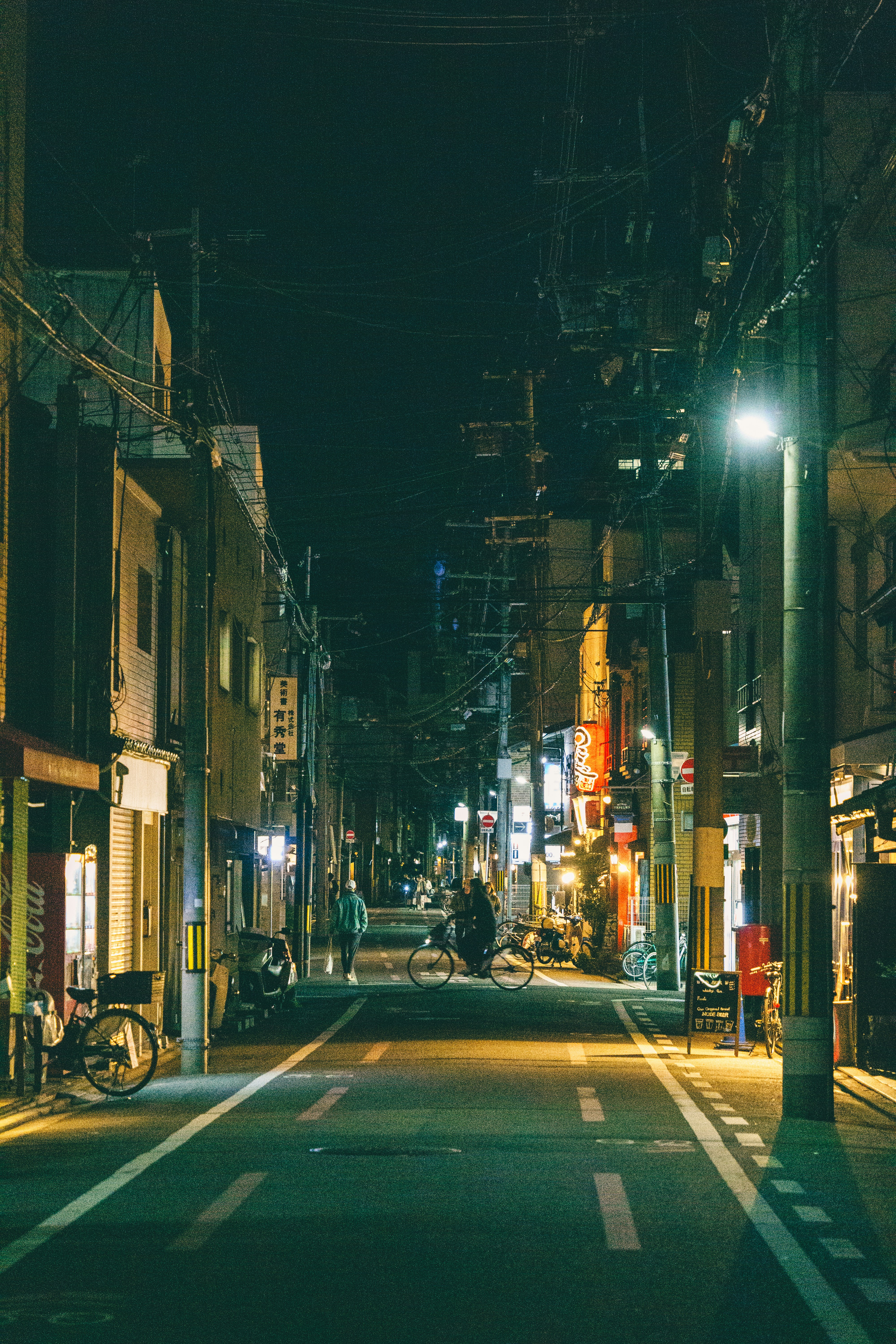 Neon Alley Quietly Alive: Bikes and Lanterns in a Night Street