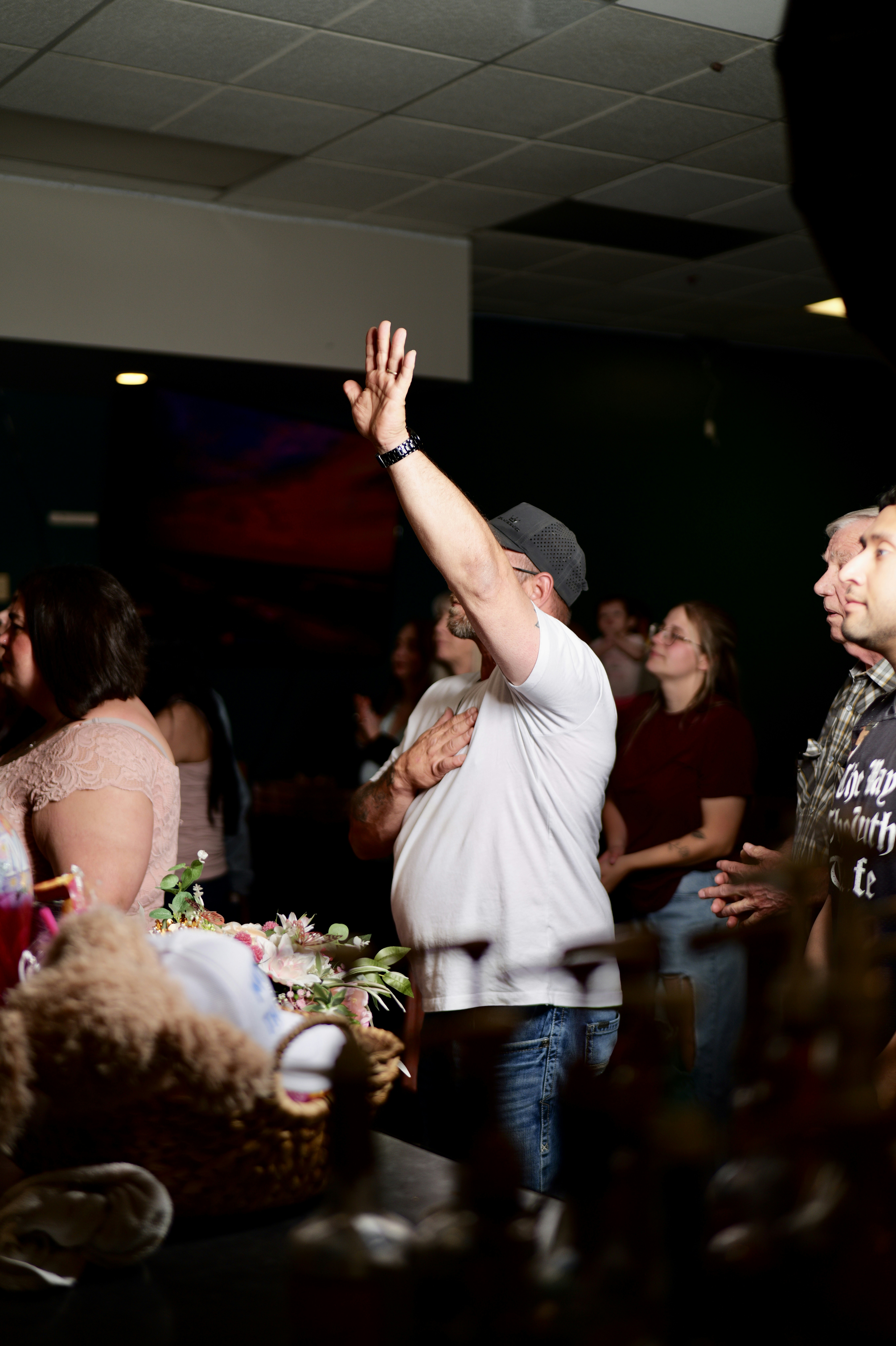 Raised Hand, Congregation, and Evening Light