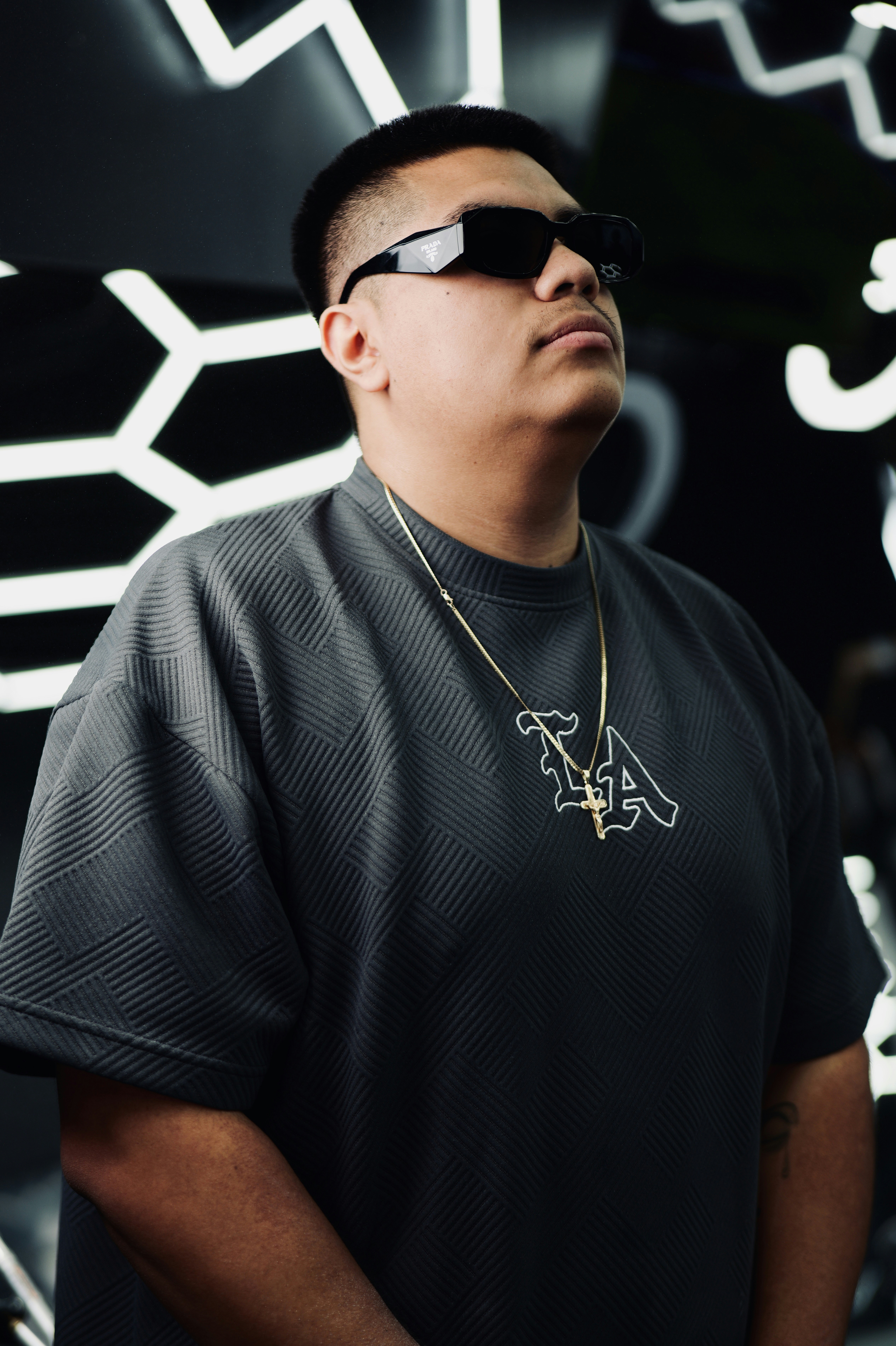 Neon-lit stance: a bold portrait under geometric glow