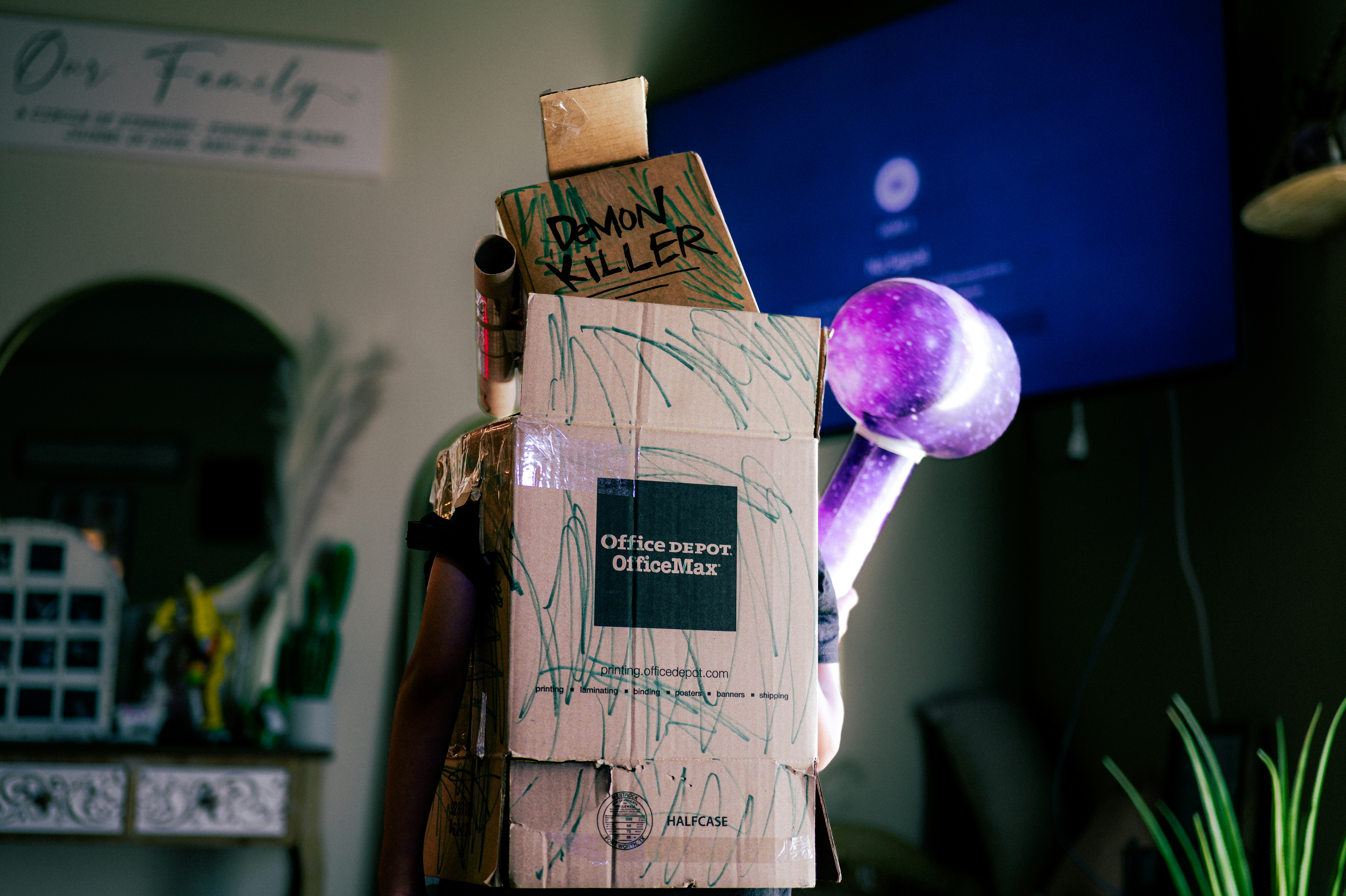 Cardboard Box Creature with Purple Globe: A Quirky Office-Set Masquerade