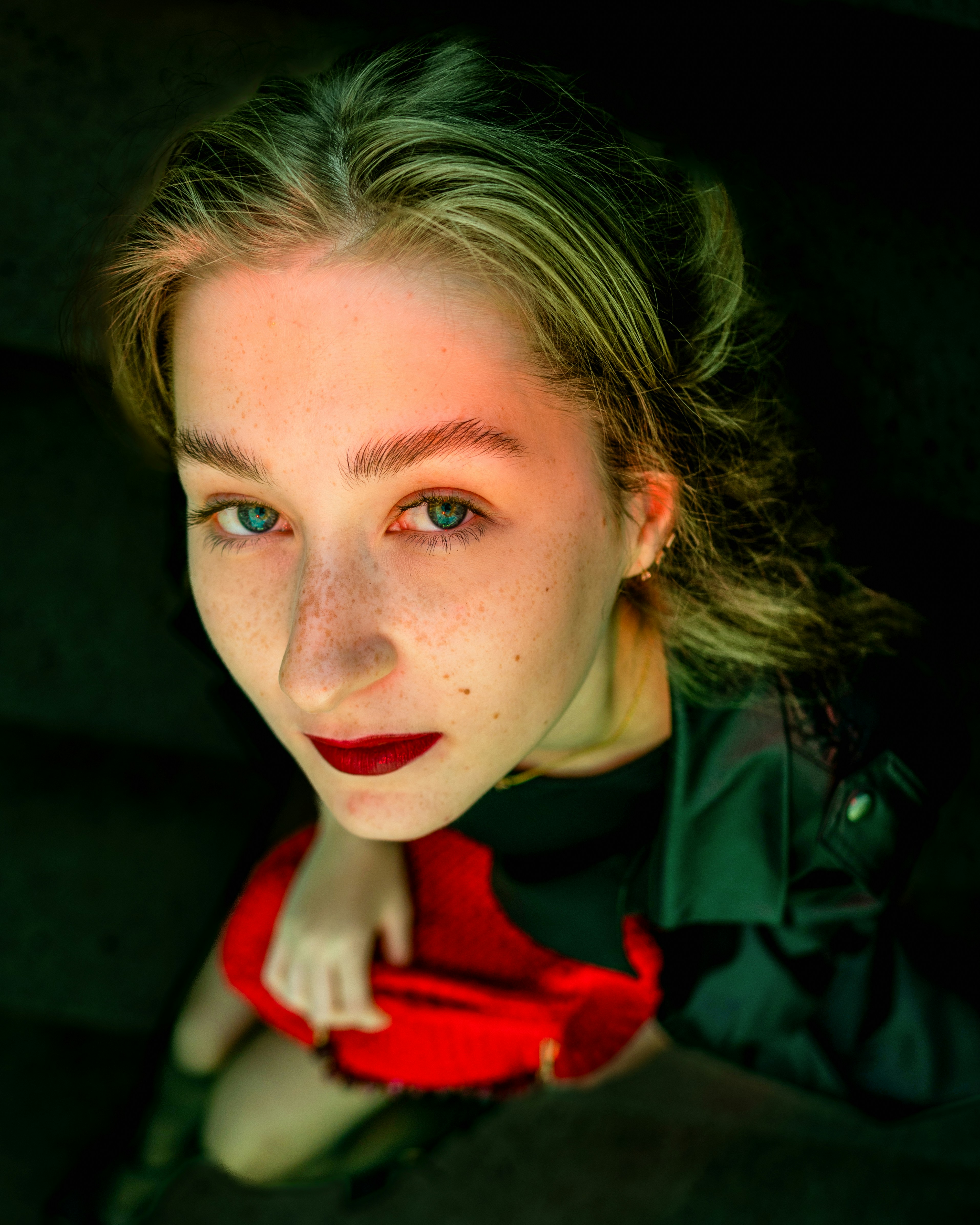 Crimson Confidence: Close-Up of a Freckled Gaze