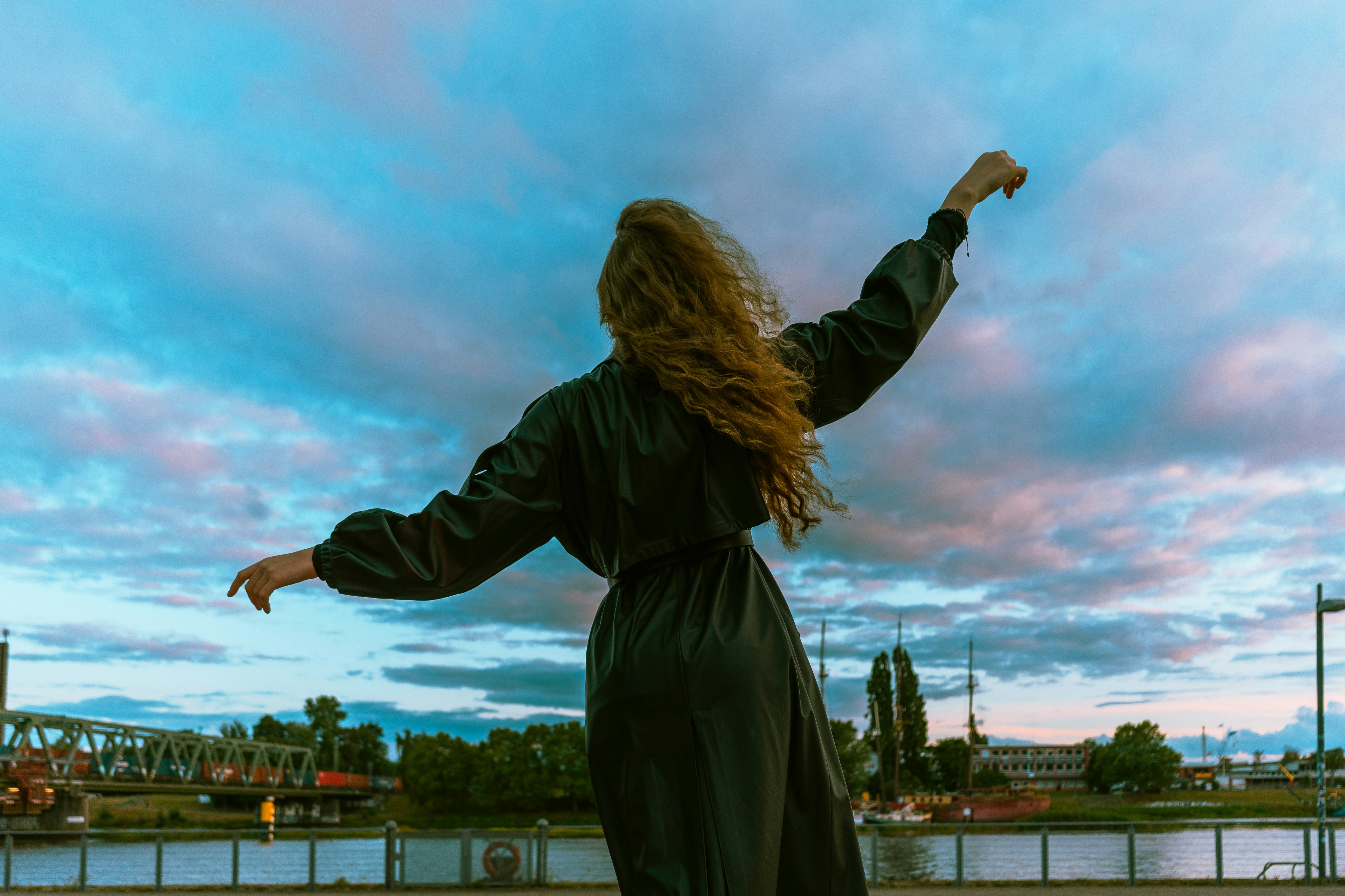 Liberation at the Riverbank: A Backlit Leap