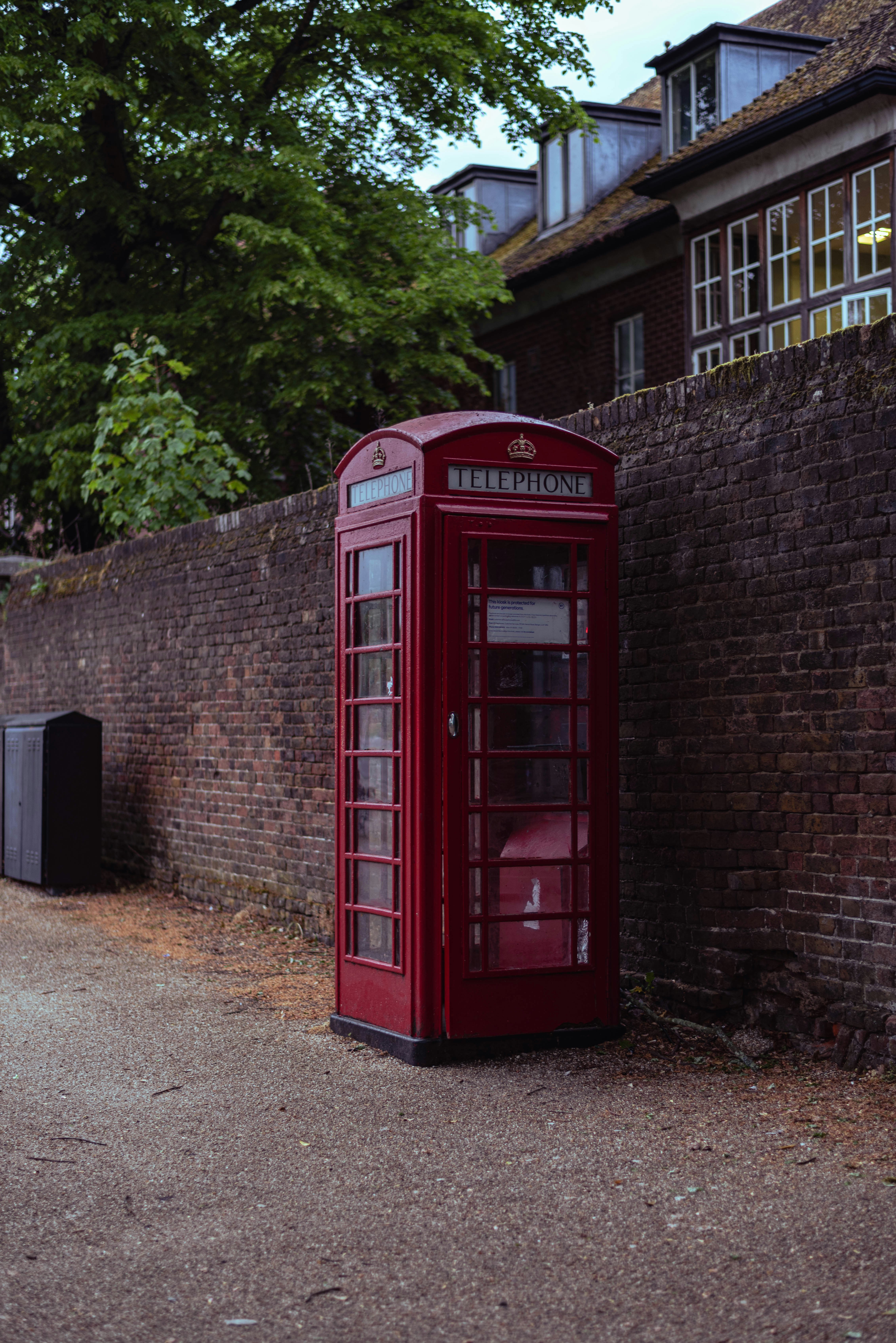 The Red Kiosk by the Brick Wall