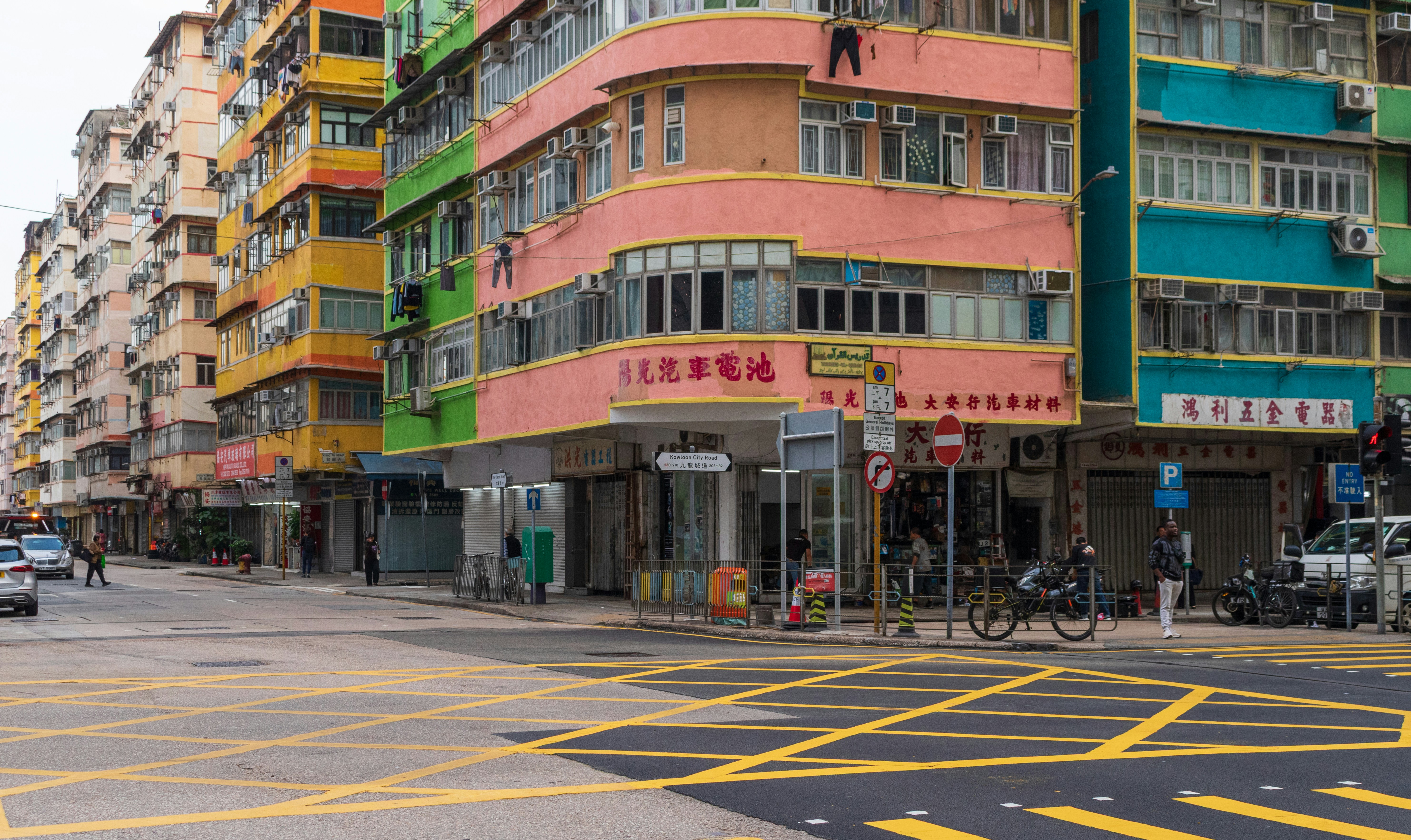 Colorful concrete streetscape: stacked storefronts and crosswalk geometry