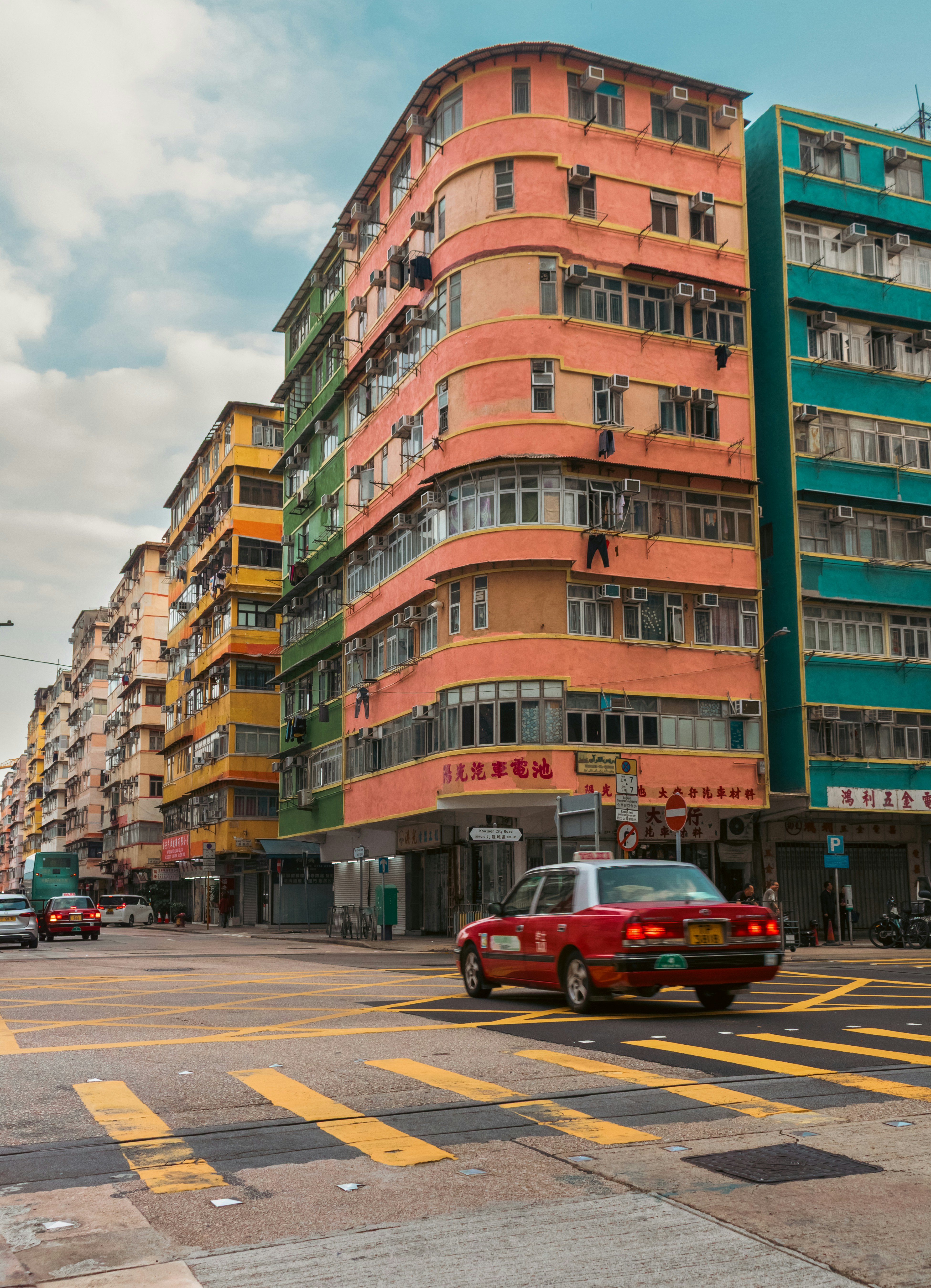 Vibrant Street Canyon: Colorful Apartment Buildings Meet Moving Traffic