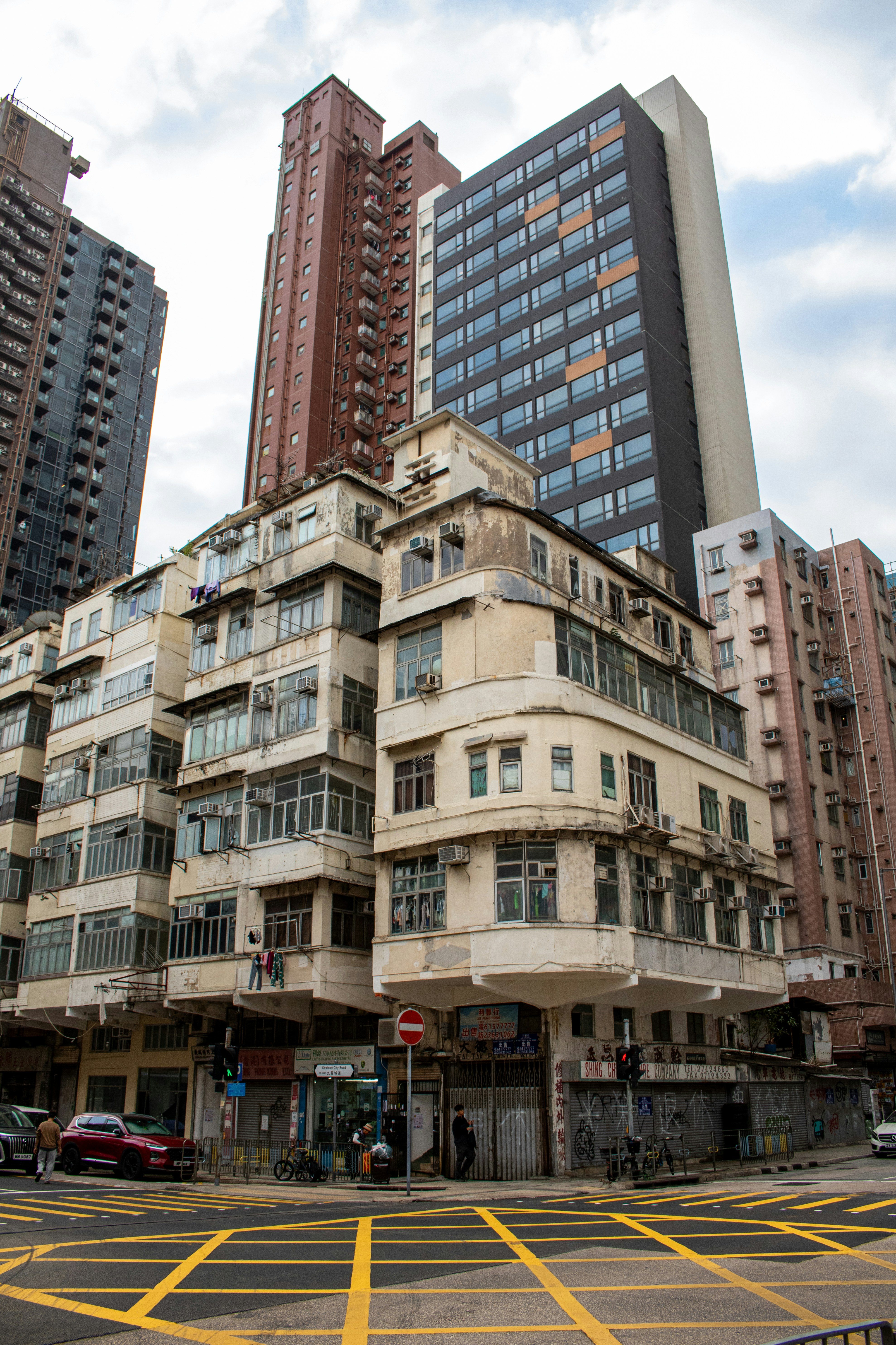 Urban Convergence: A Weathered Corner Beneath Modern Glass