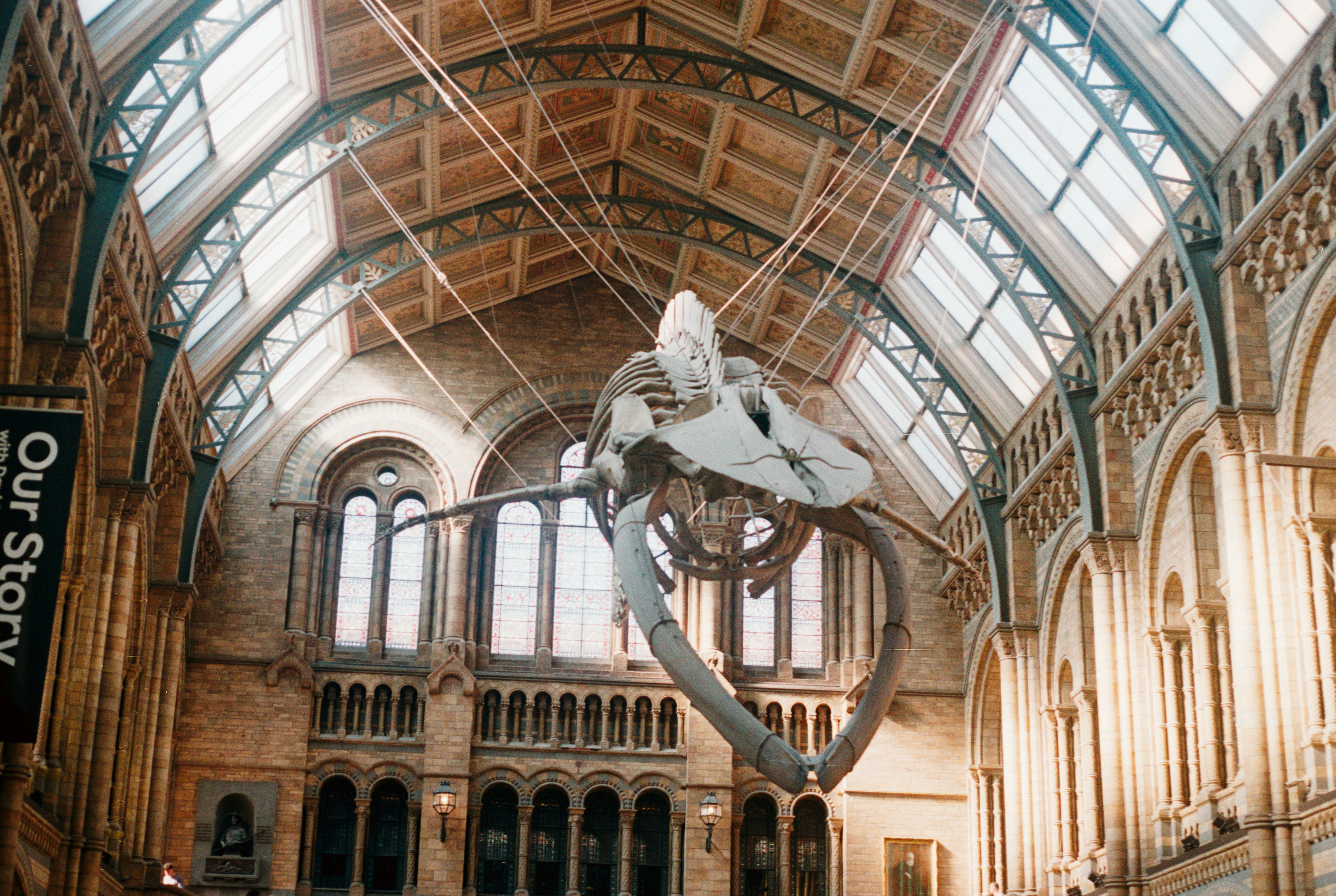Timeless Rotation: A suspended sculpture in a glass-topped hall