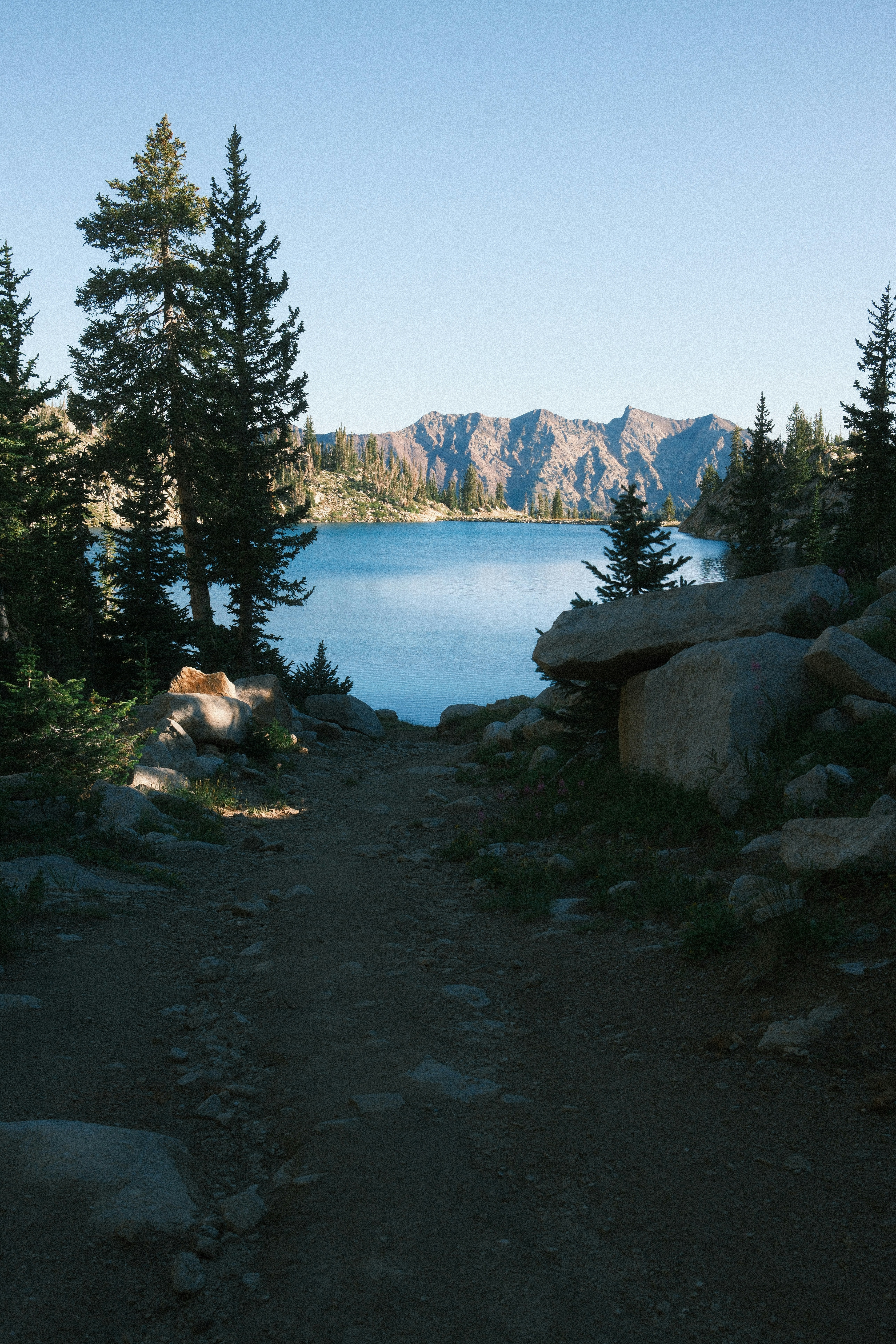 Trail to a Quiet Lake Under Alpine Peaks