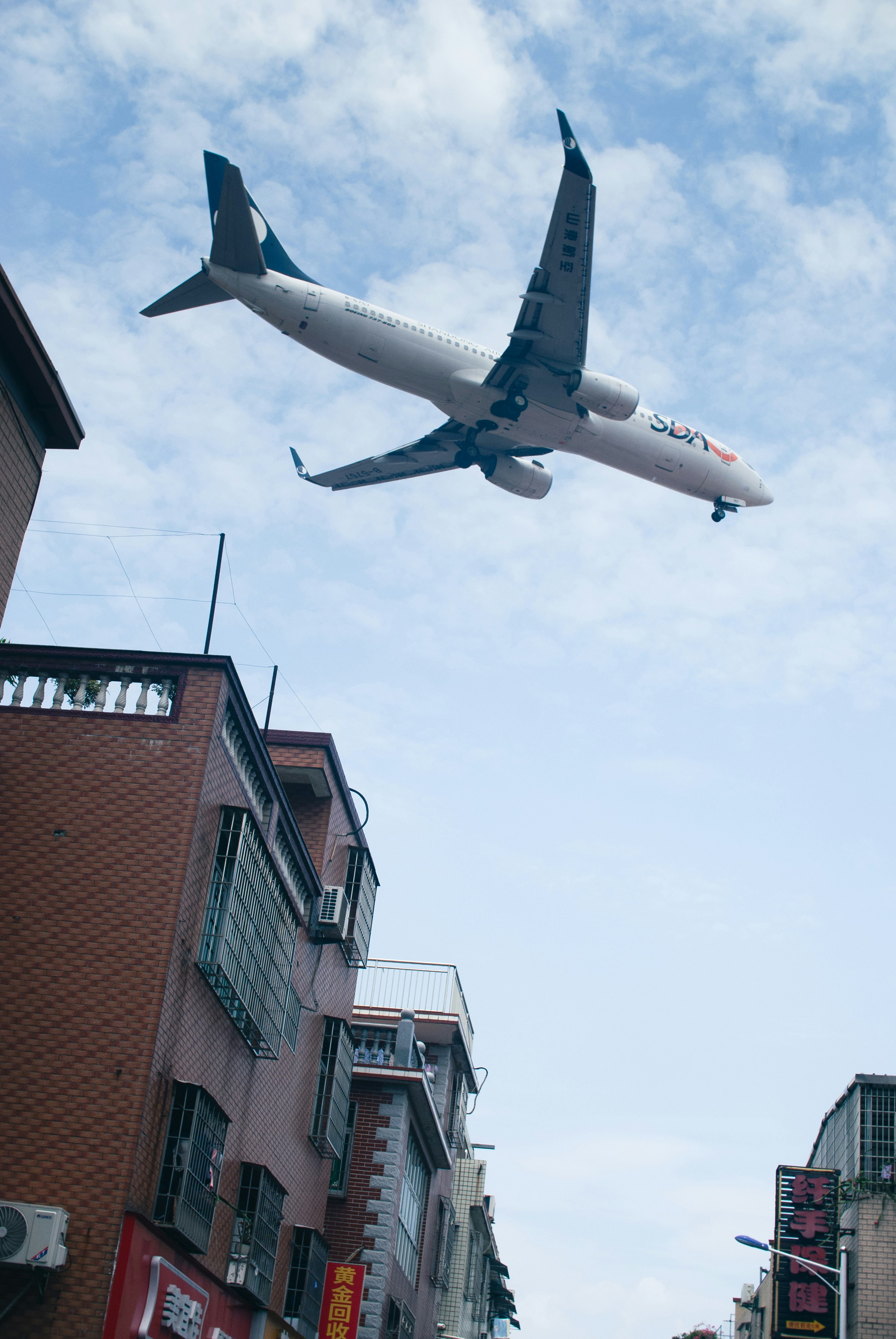 Jet over the City: A Narrow Stride of Sky