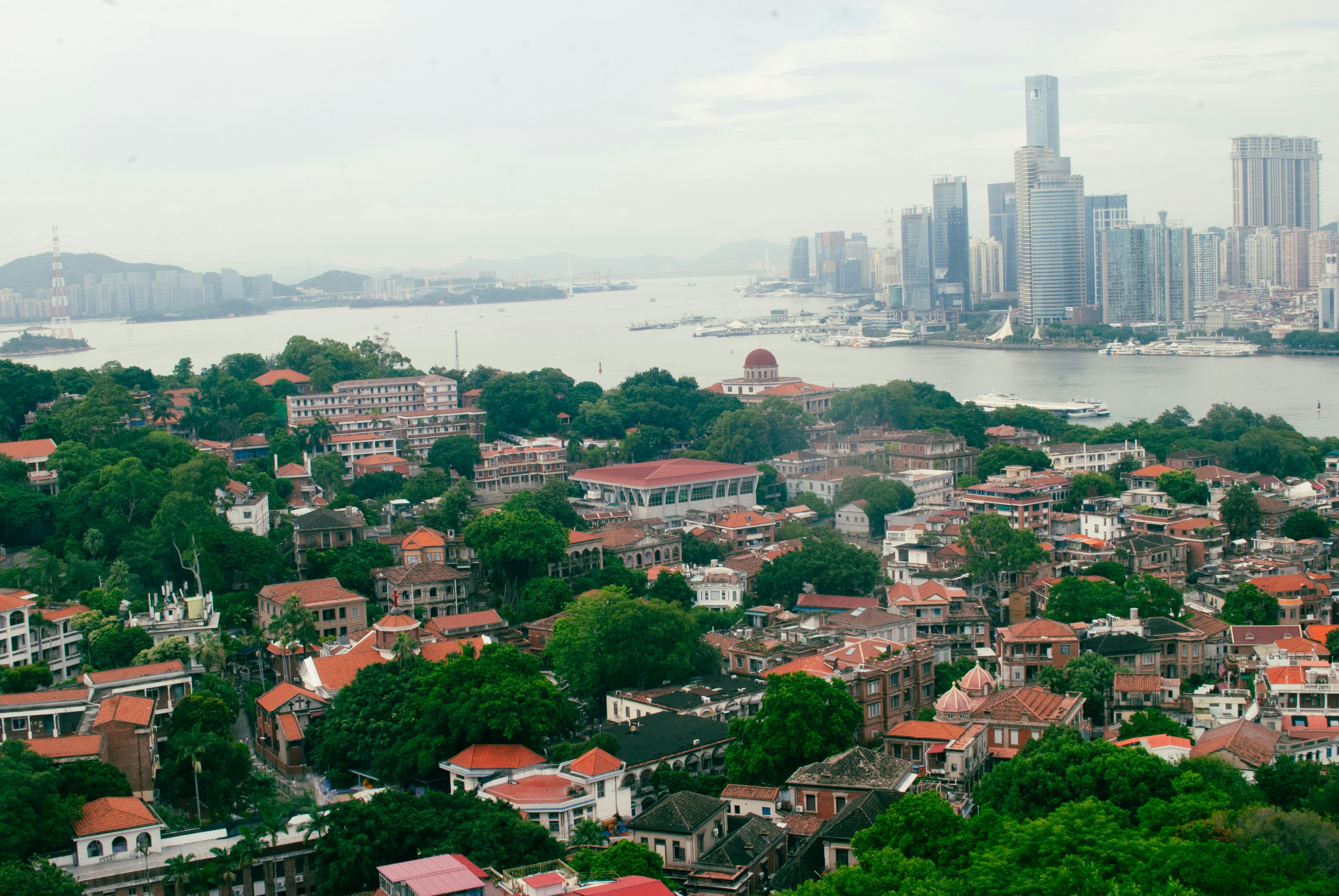 Cityscape Convergence: Riverside roofs meet a modern skyline