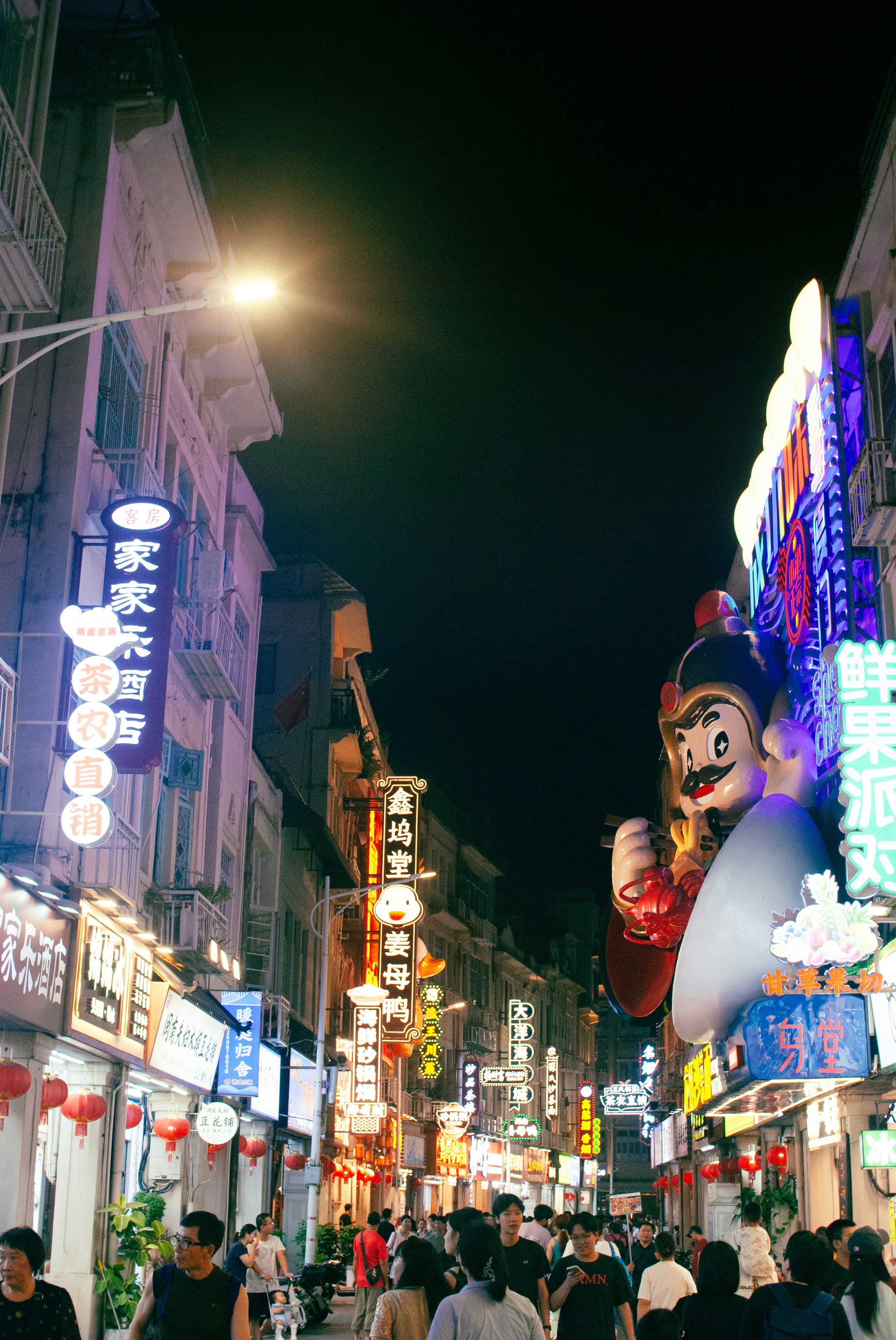 Neon Alley: Lanterns, Crowds, and a Giant Festive Figure