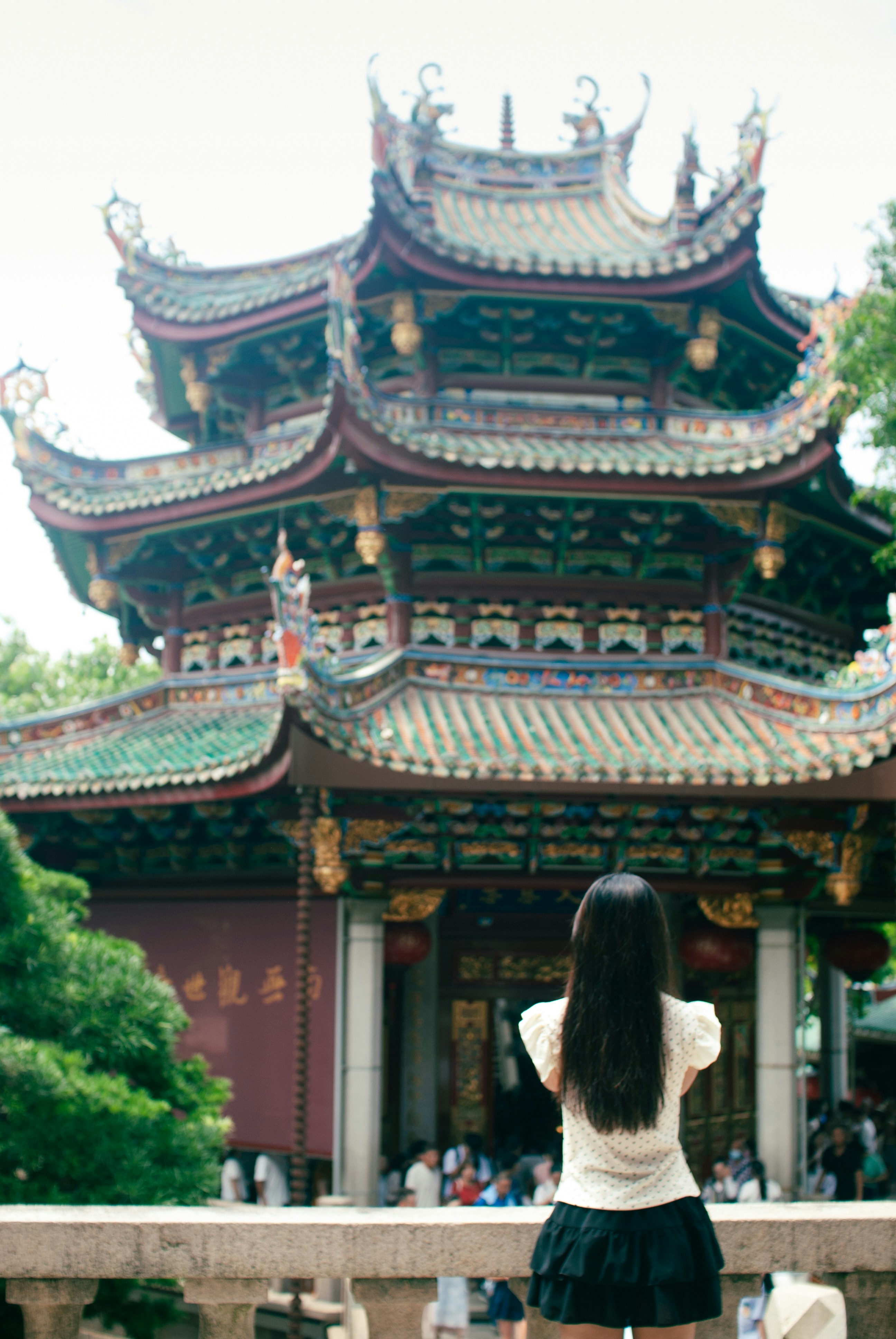 Front-and-Center Moment: A Visitor Facing the Lantern-Topped Pagoda
