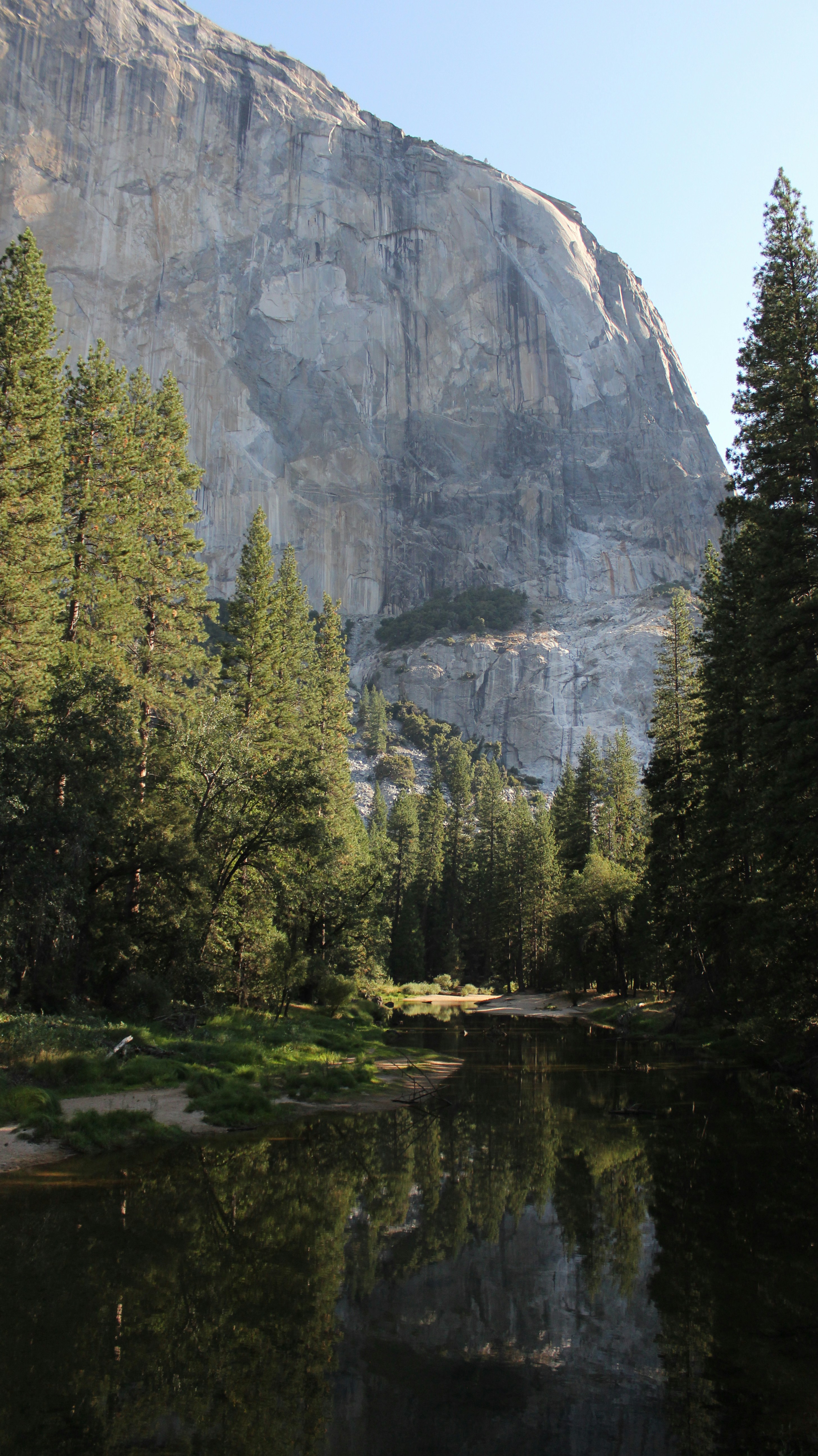 Monolithic Guardian: A Sierra Wall Rises Over a Mirror-Like River