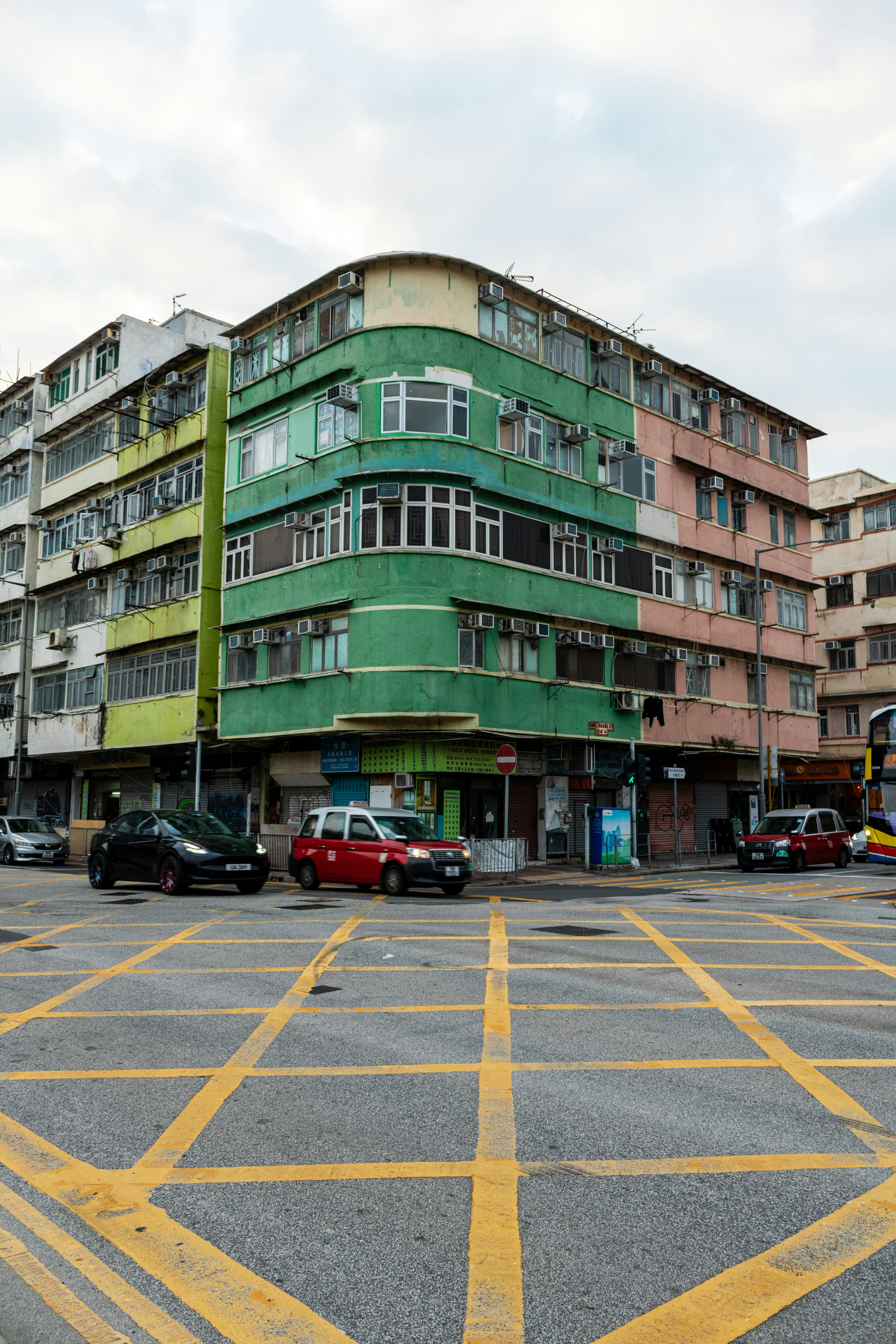 Verdigris Corner: A Green-Faced Block Framed by a Tiled Street Grid