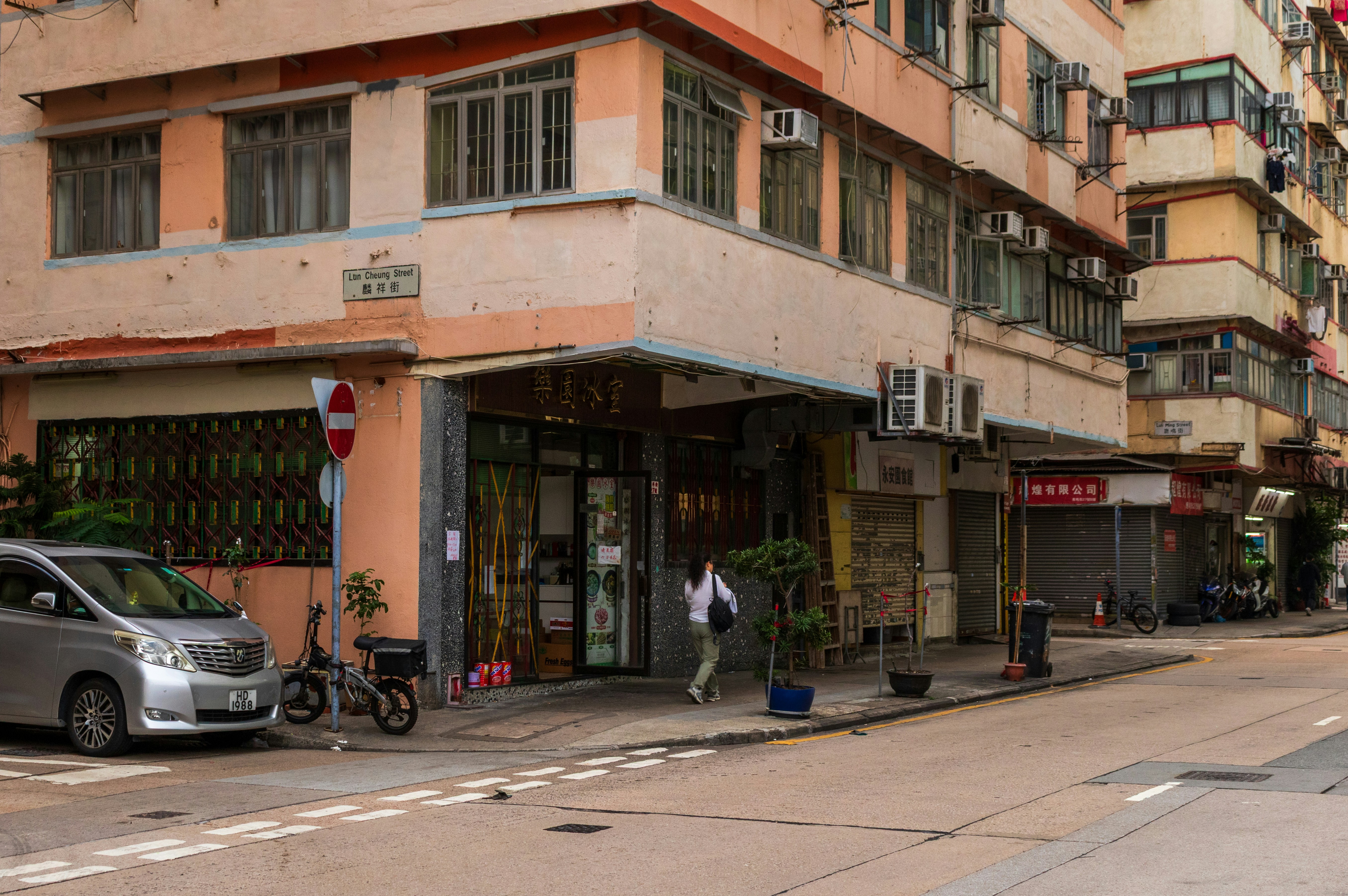 Ground-floor Shopfront Looms Over Quiet Street with Pedestrian