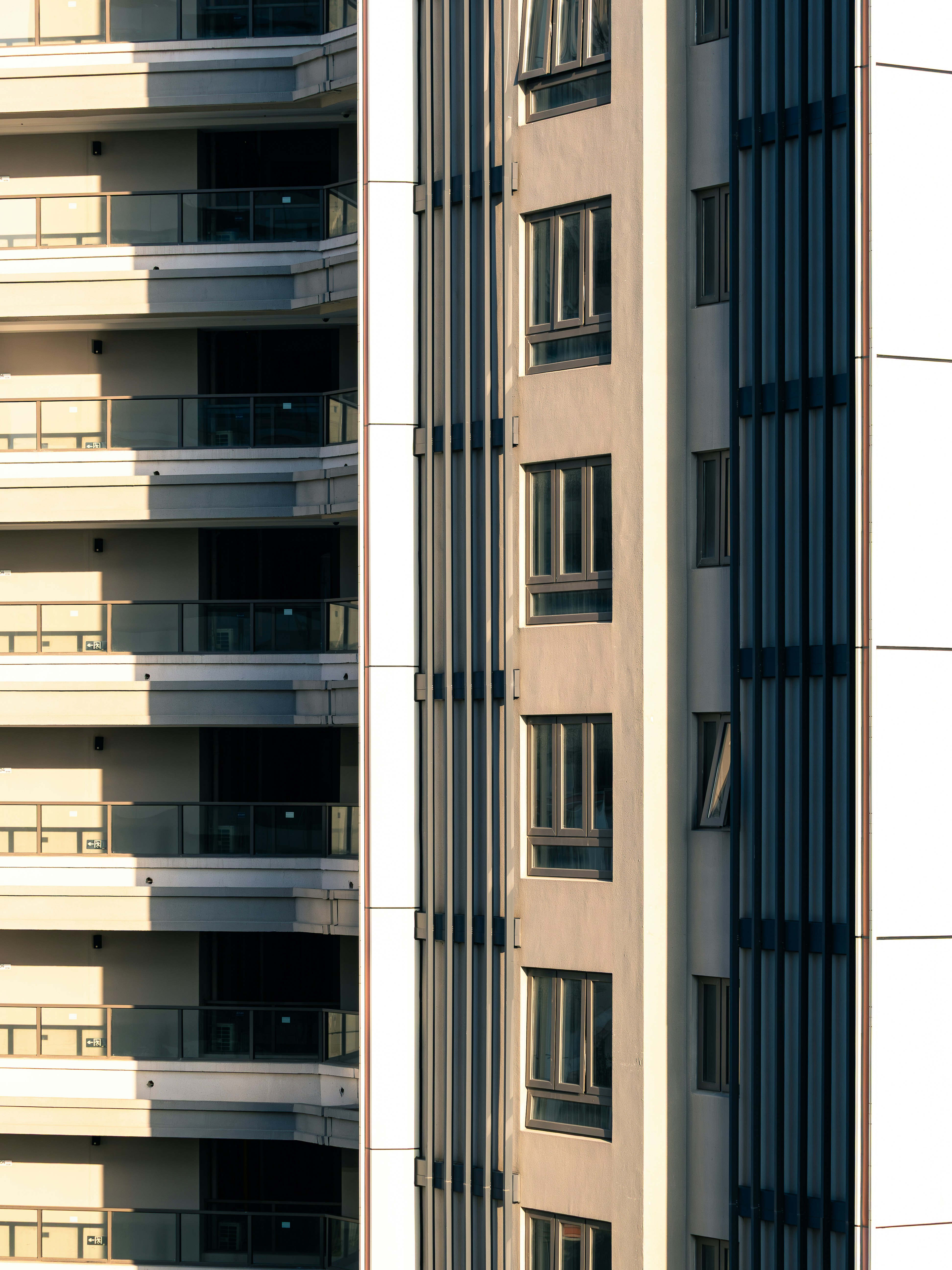Vertical Facades: Sunlit Stripes Crossing a Modern Cliff