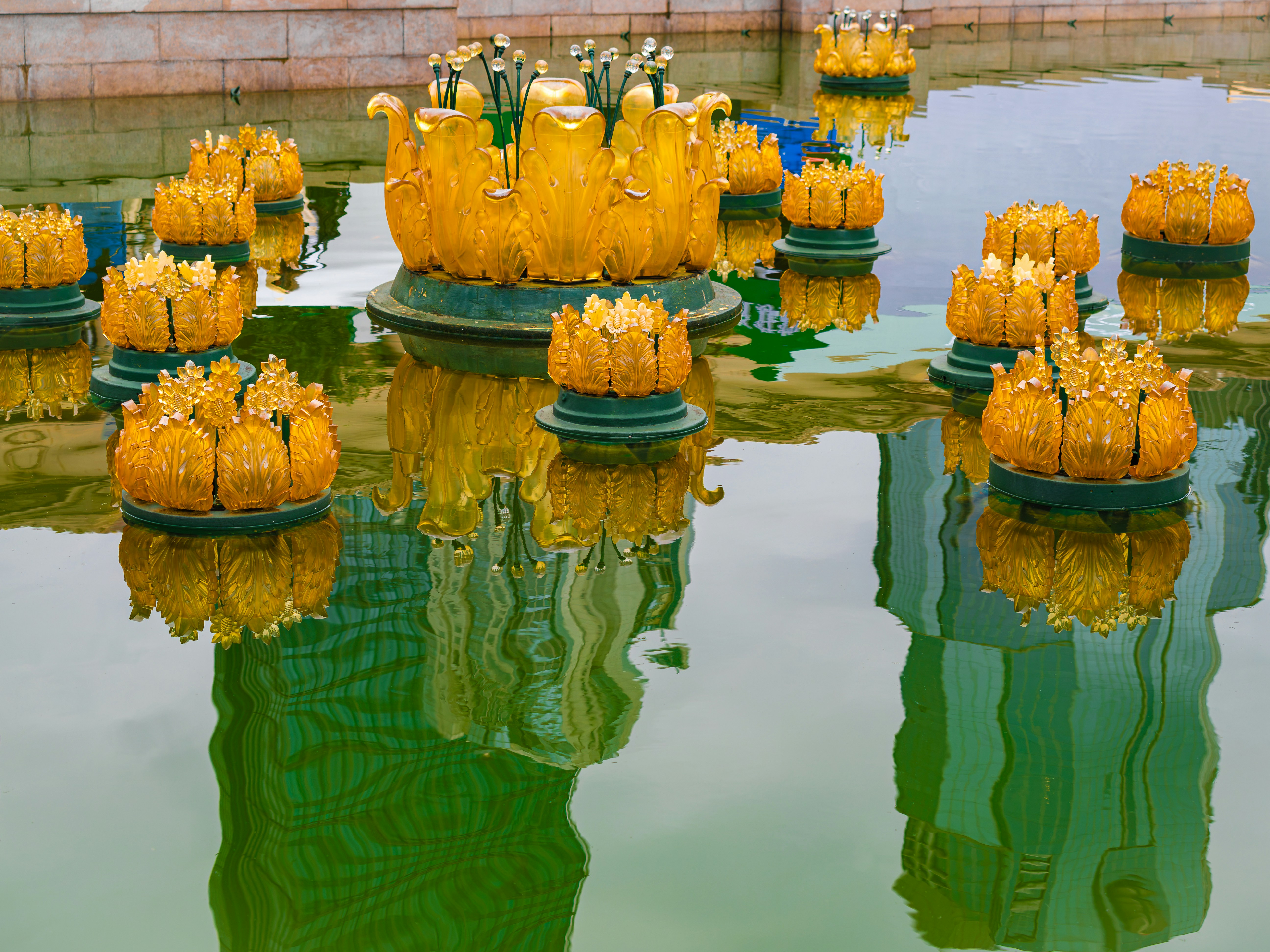 Golden Fountains: Reflections and Robed Orbs in a Tranquil Pool
