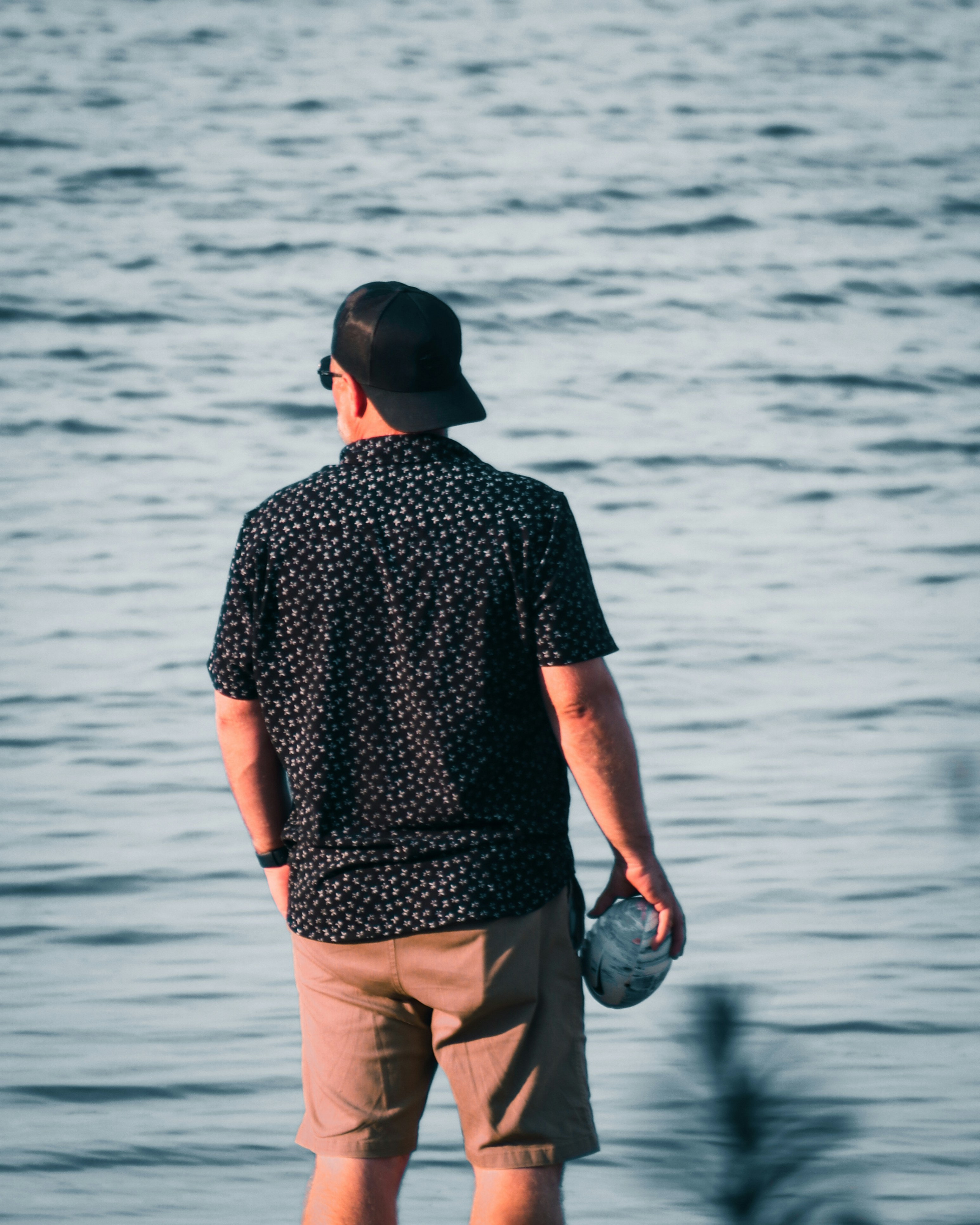 Silhouette by the Sea: A Back View at Dusk