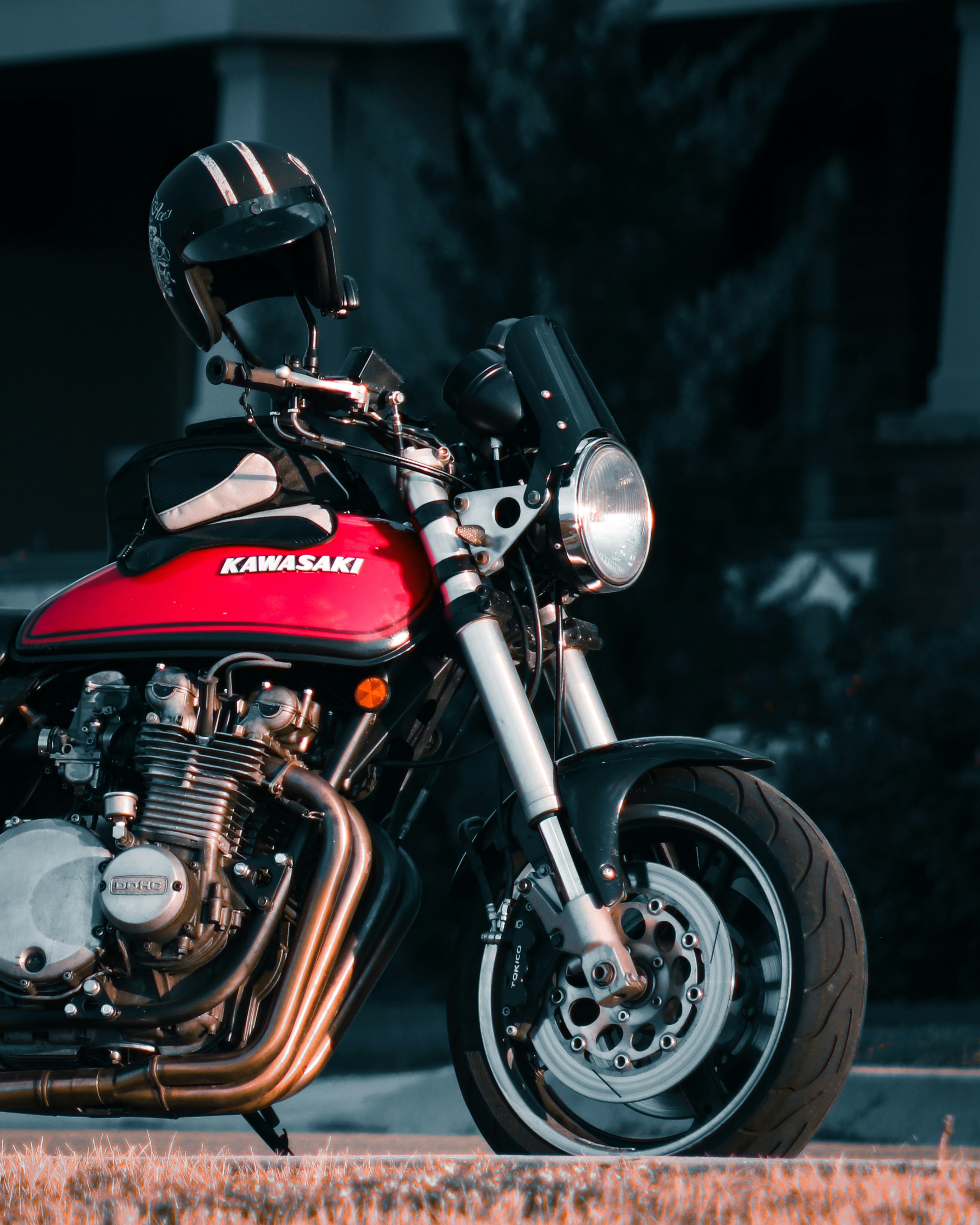 Red Machine in Focus: A Kawasaki Classic Resting by the Drive