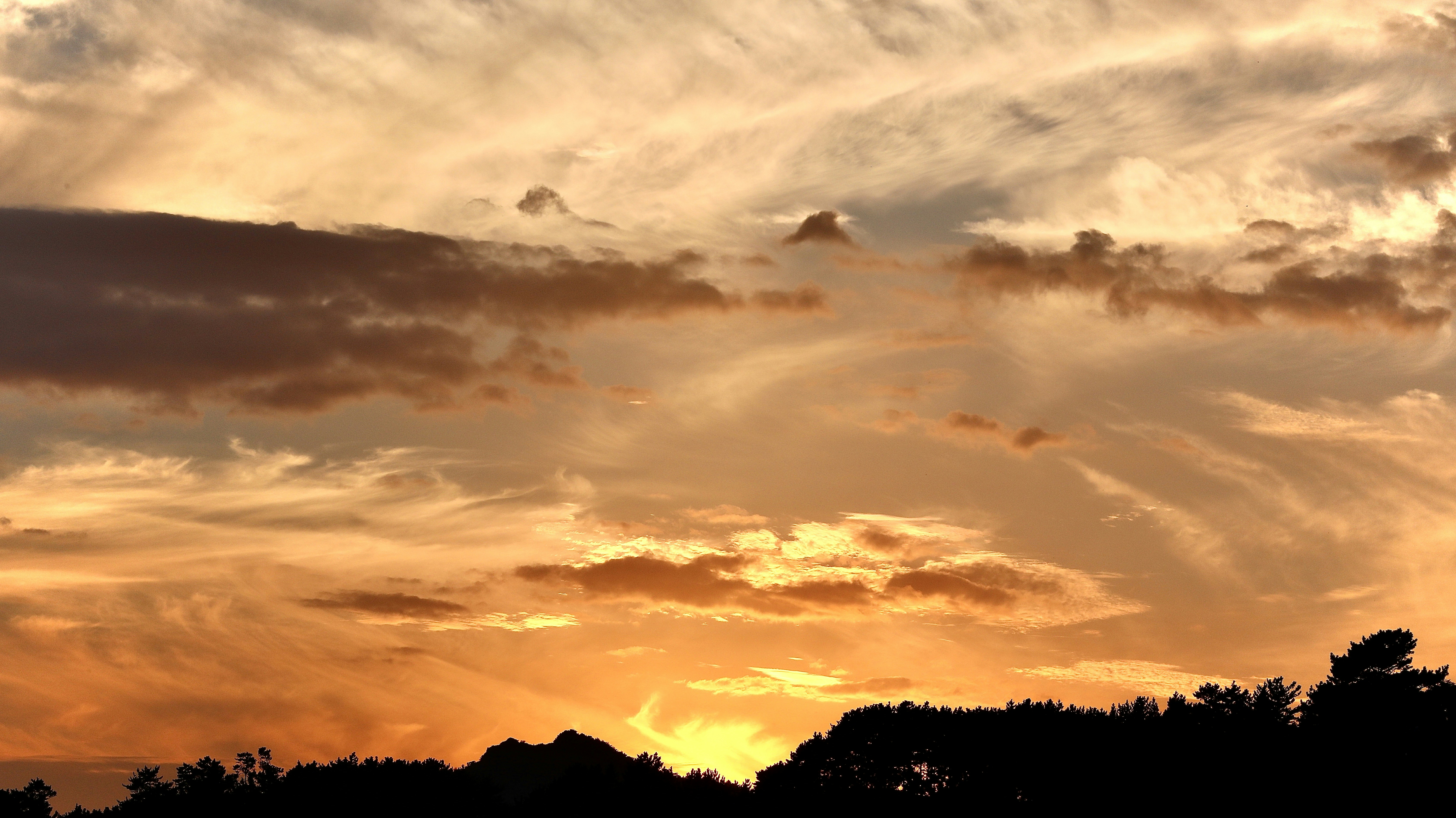 Sunlit Crest: A Quiet Horizon Beneath Fiery Skies