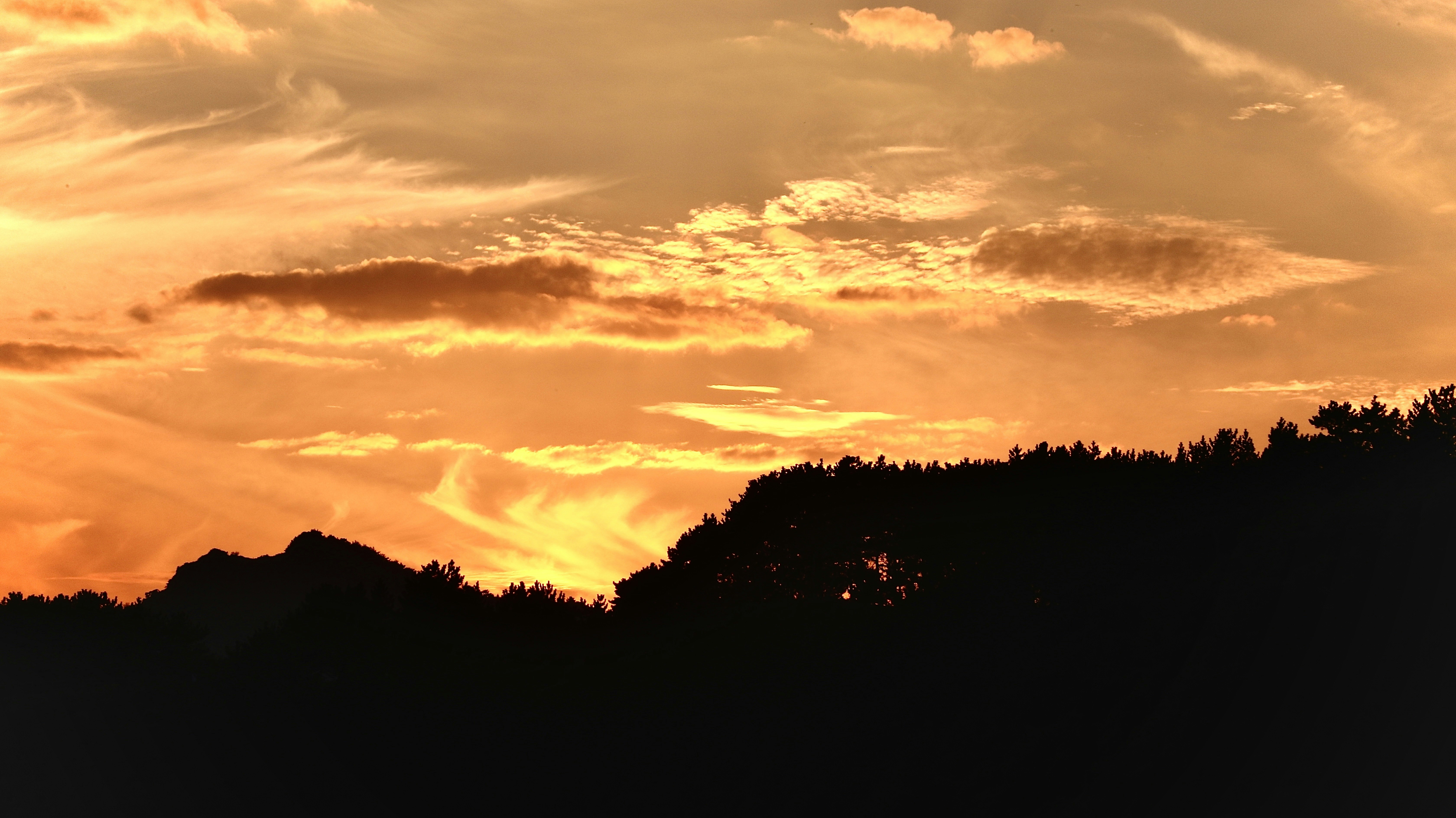 Dusk Crown: Silhouetted Horizon Under a Fiery Sky