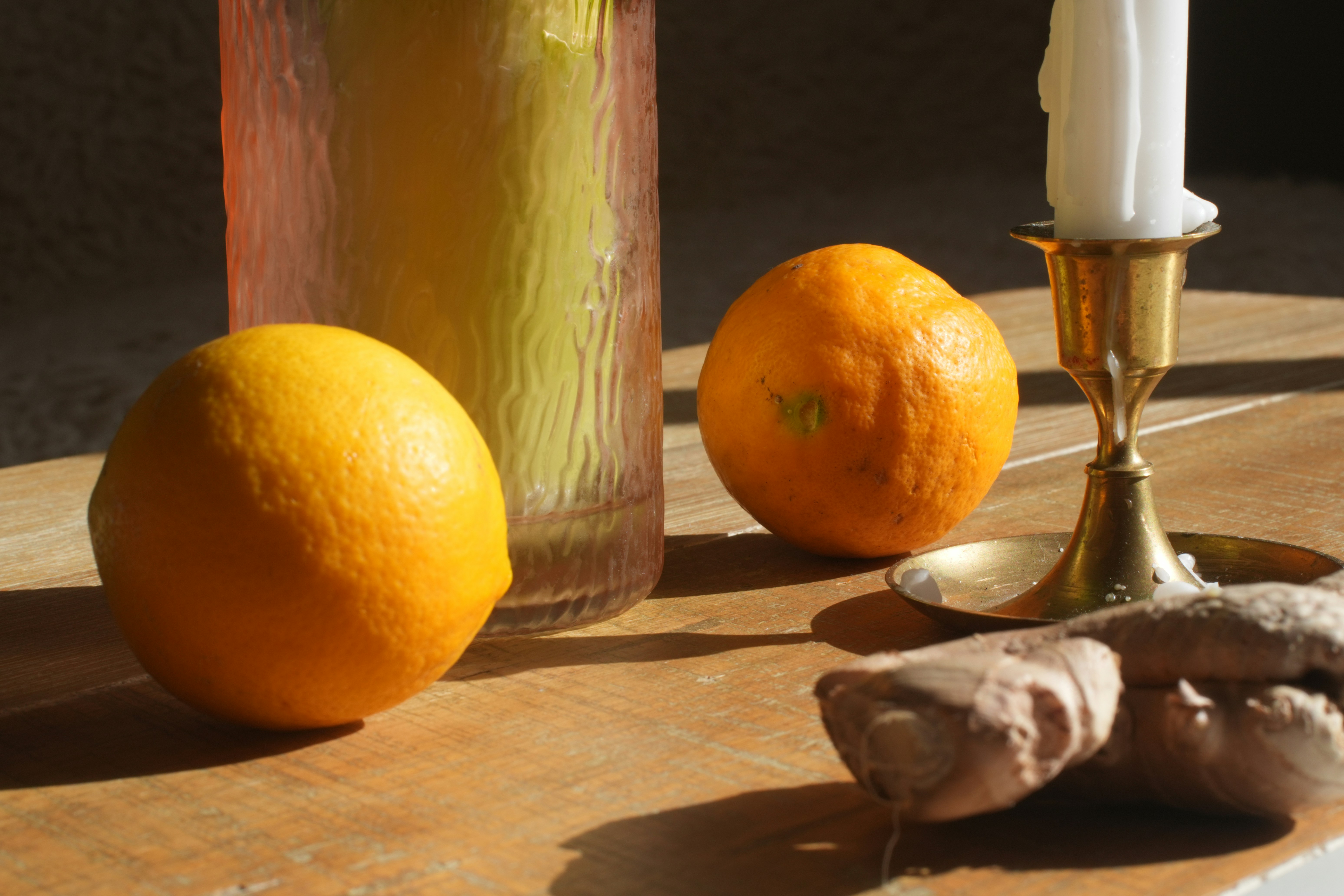 Citrus and Candlelight: A Quiet Still Life on Sunlit Wood