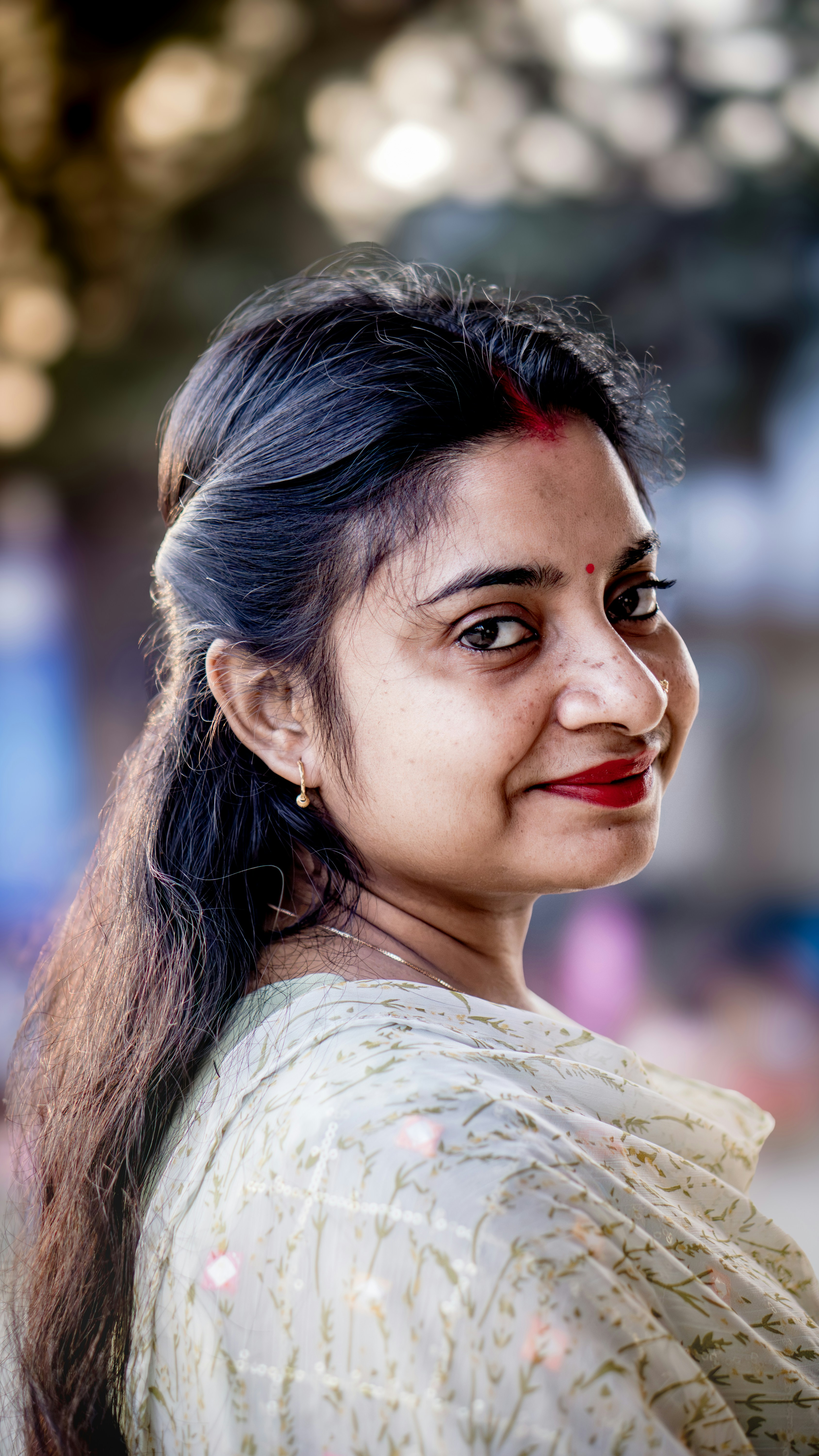 Soft Smirk, Vivid Tradition: A Portrait of Quiet Confidence