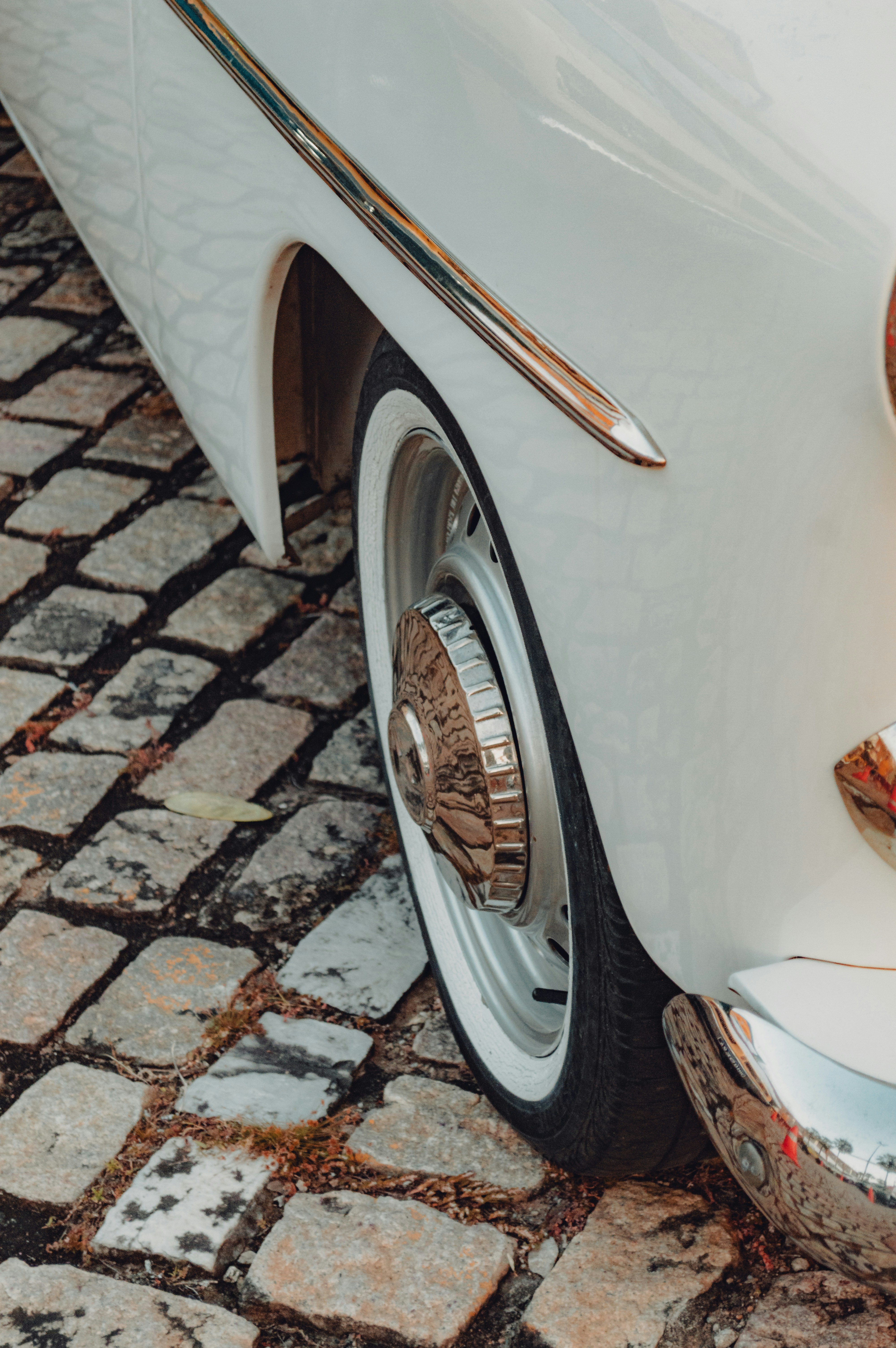 Quiet Elegance on Cobbled Canvas: A Classic Car’s Side Profile