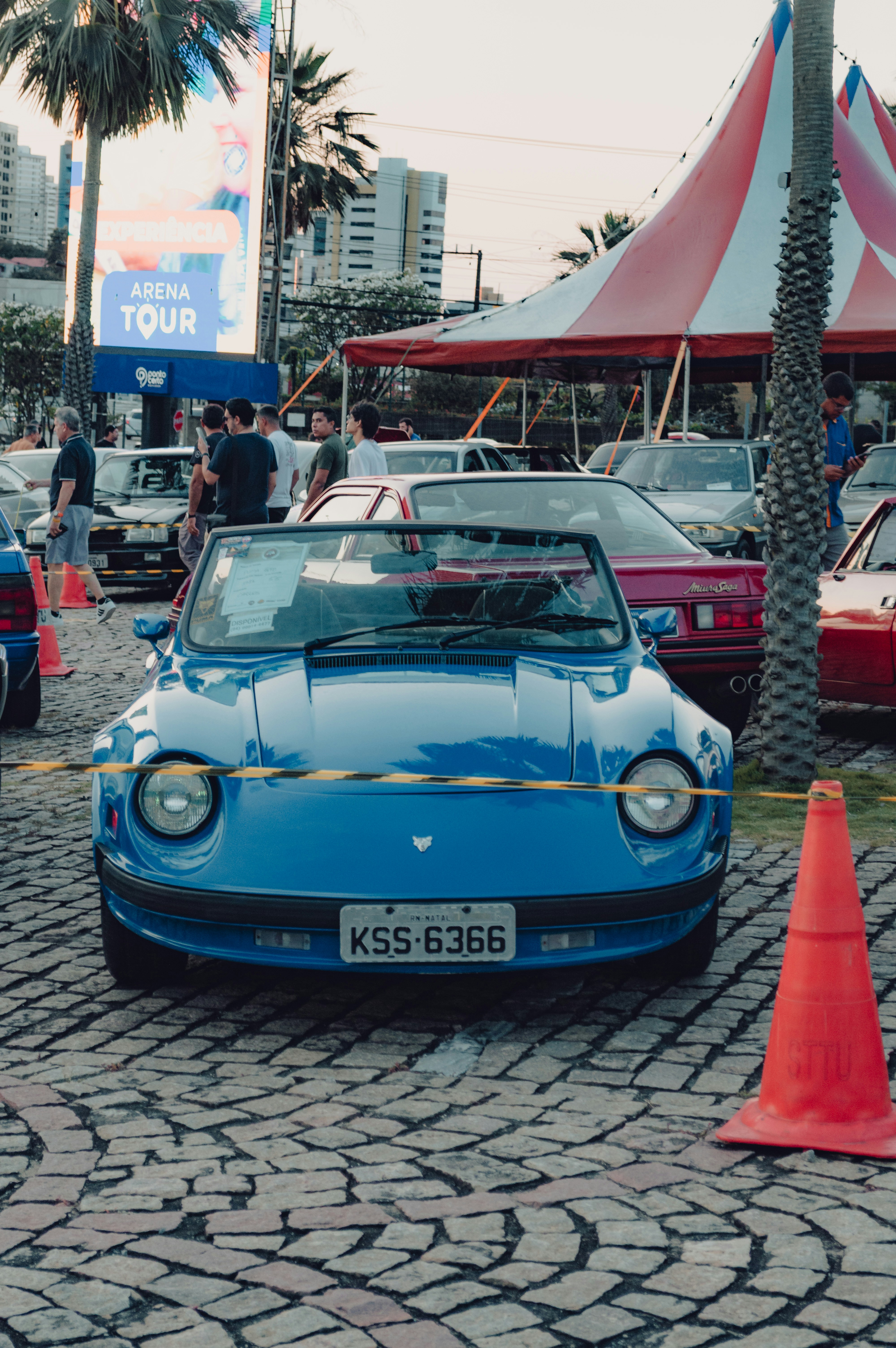 Blue Retro Roadster Under the Crescent of a Palma-topped Parade