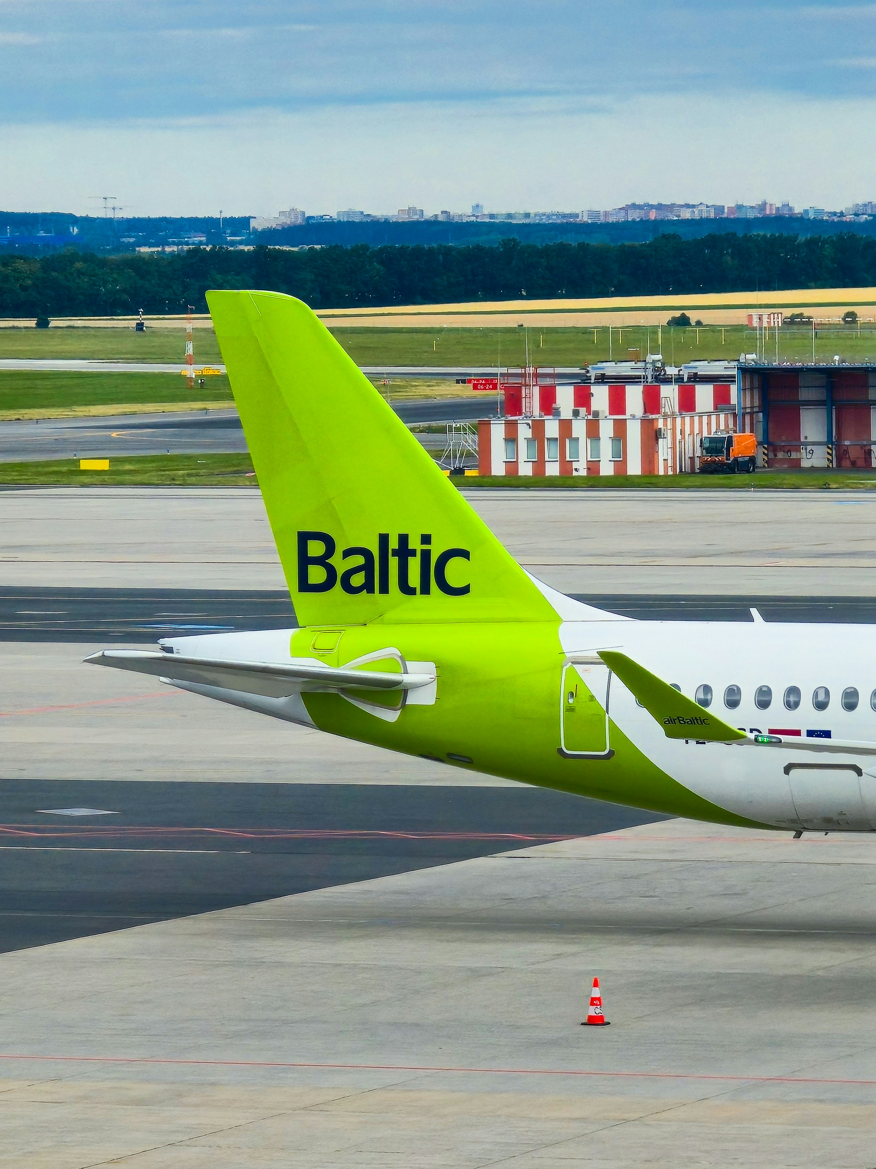 Bright Lime Tail: Baltic Airbus at the Edge of the Tarmac