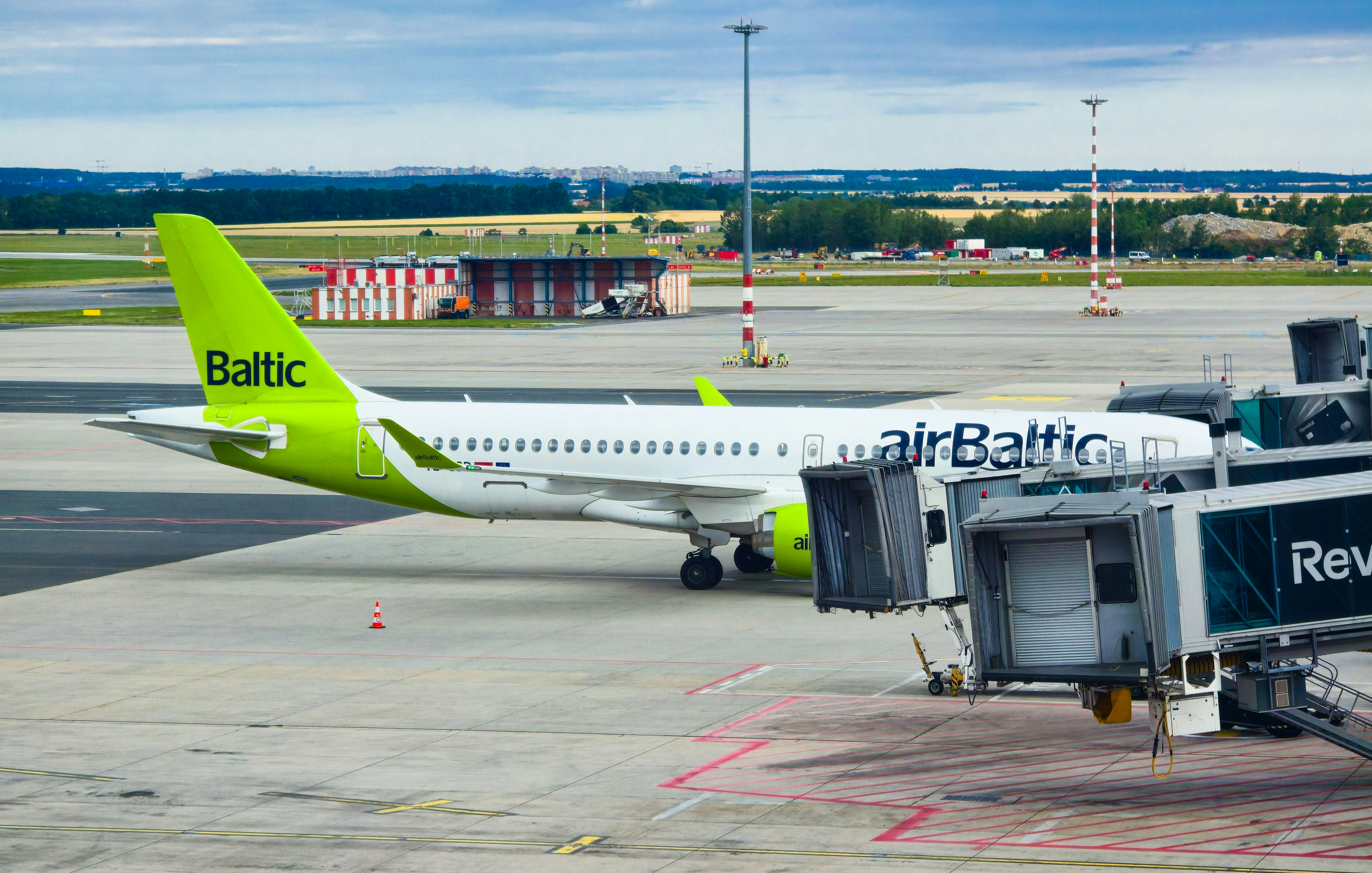 AirBaltic at Gate: Lime Tail, Bright Sky