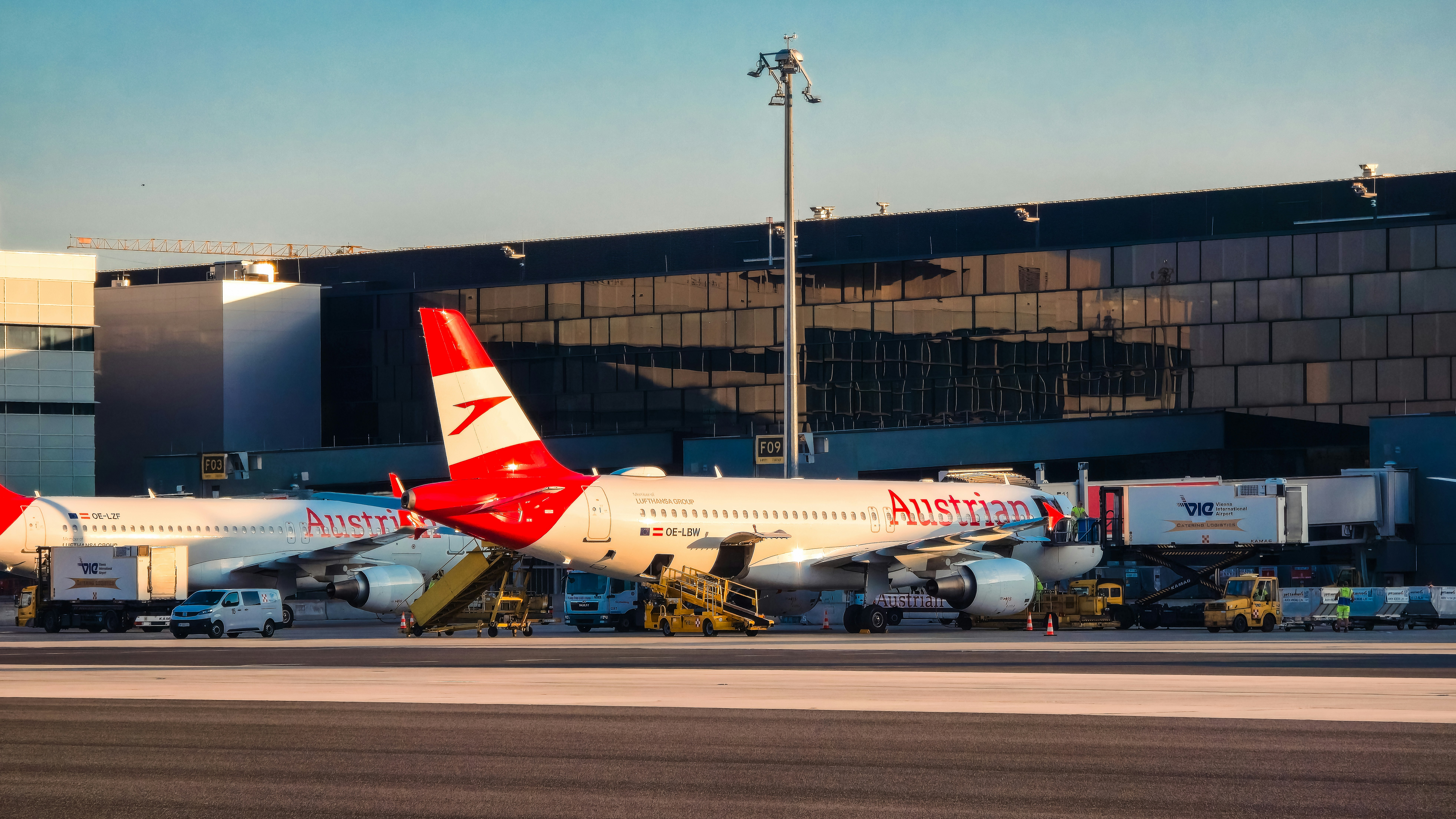 Airline at Rest: A Red-Tailed Jet Braced at the Gate