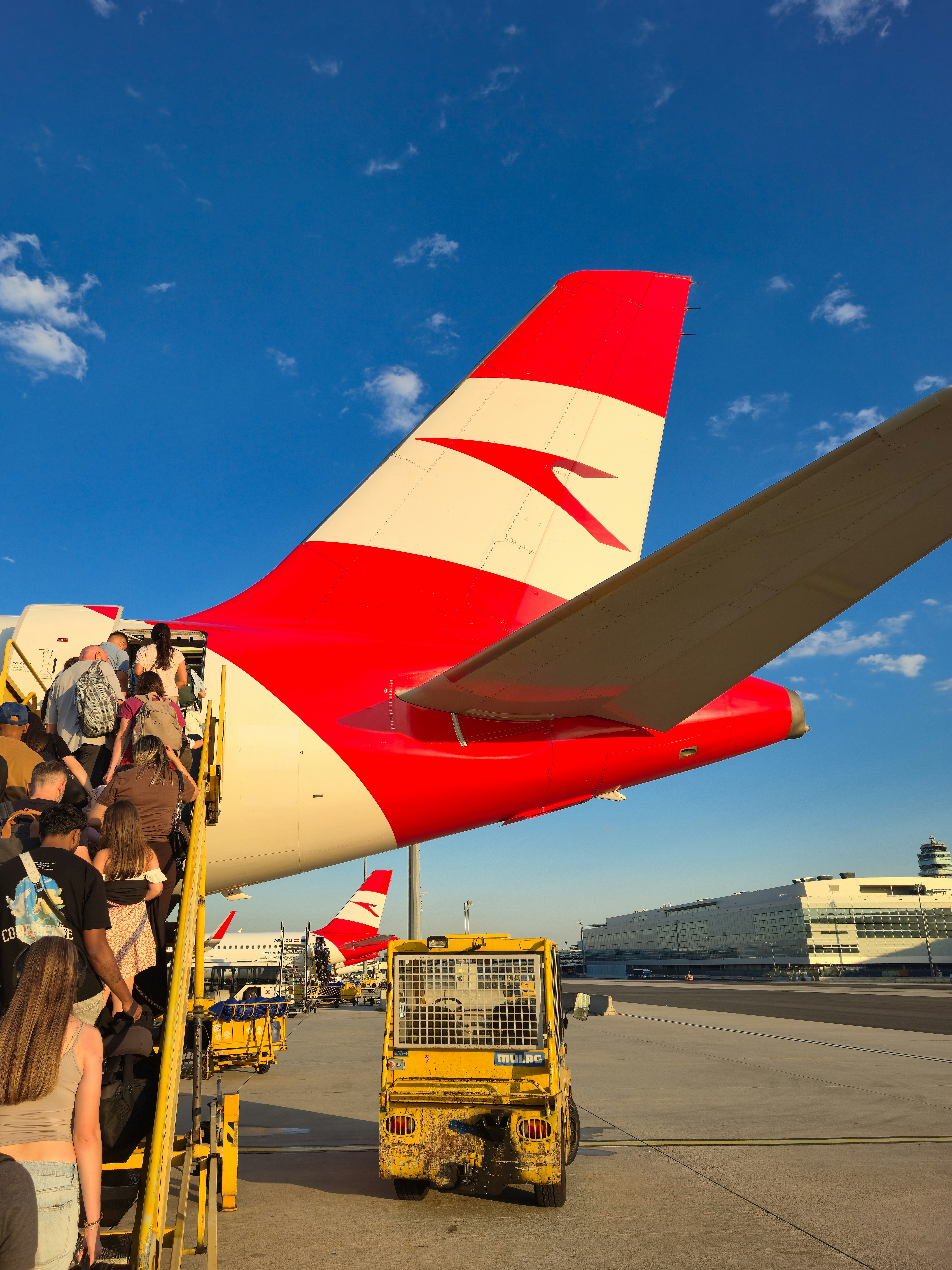 boarding a red-tailed jet: passengers queue up at the aircraft door