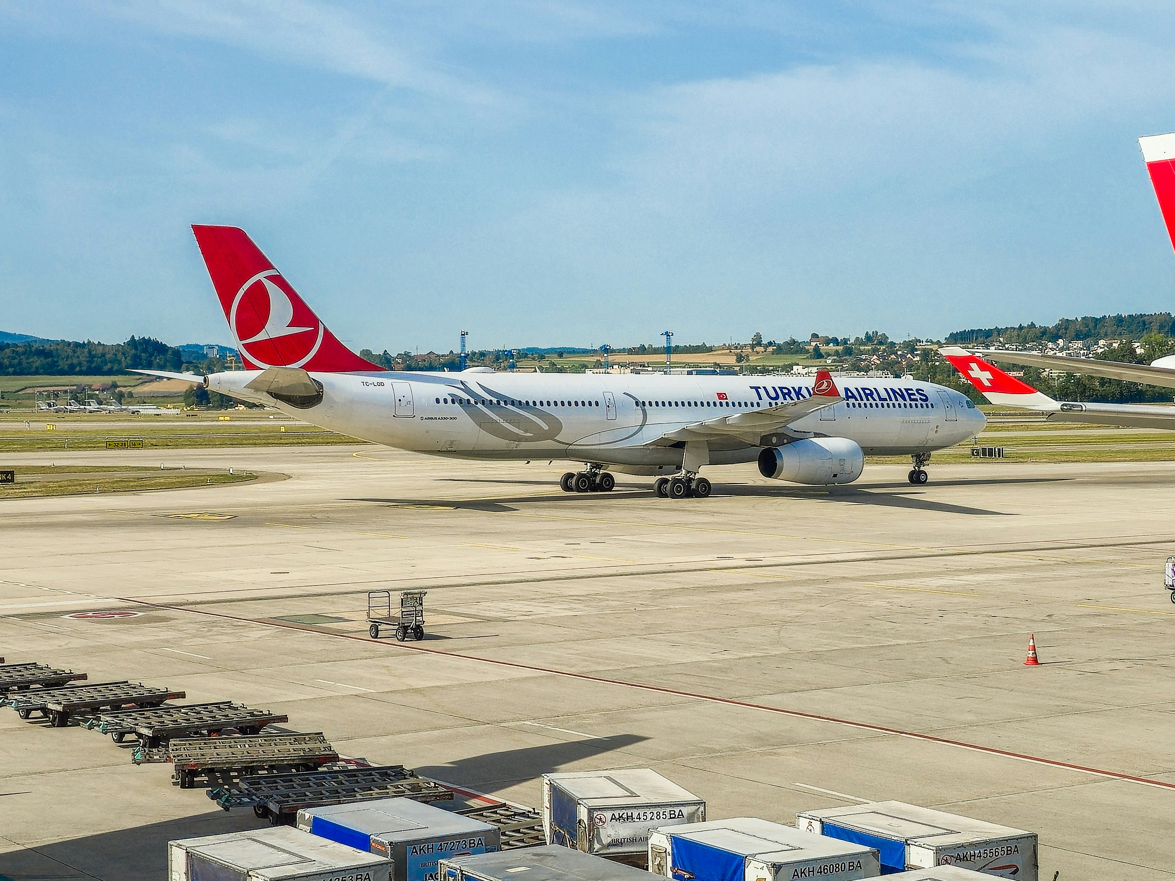 Turkish Airlines A350 gliding toward the gate under a clear sky