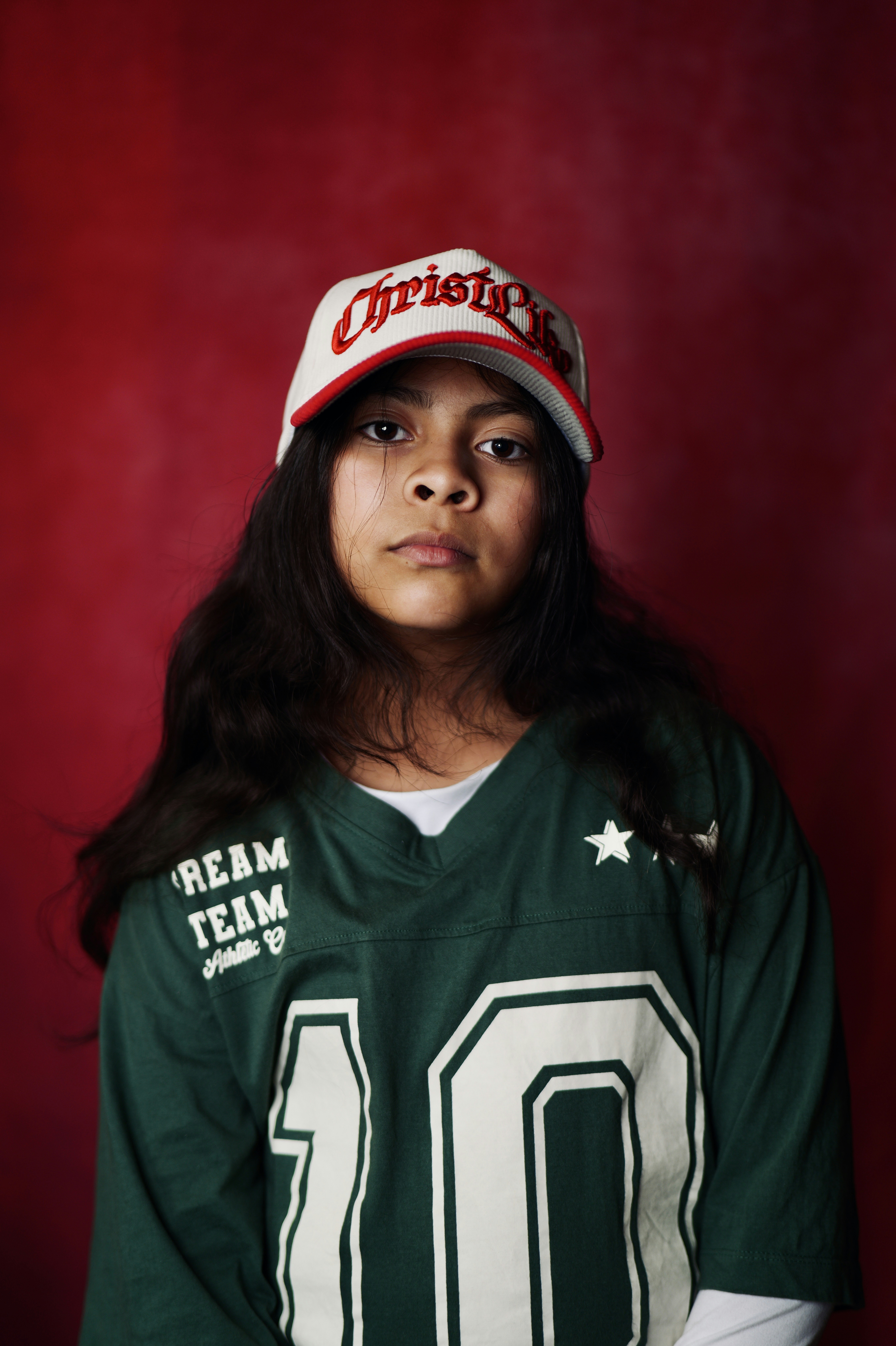 Cap and Confidence: A Portrait in Red and Green