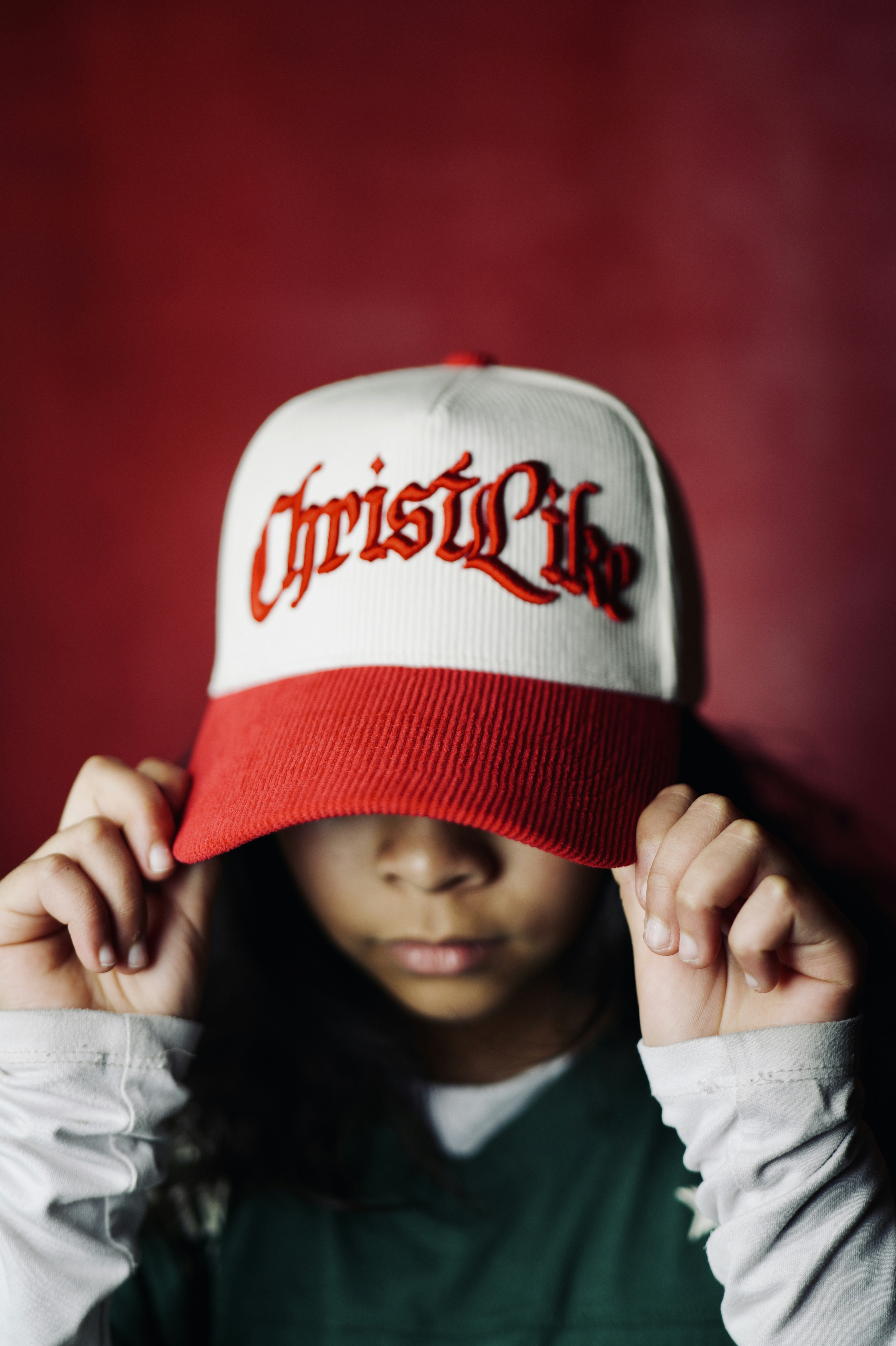 Cap Tilted Down, Secrets Hidden: A Quiet Portrait in Red and White
