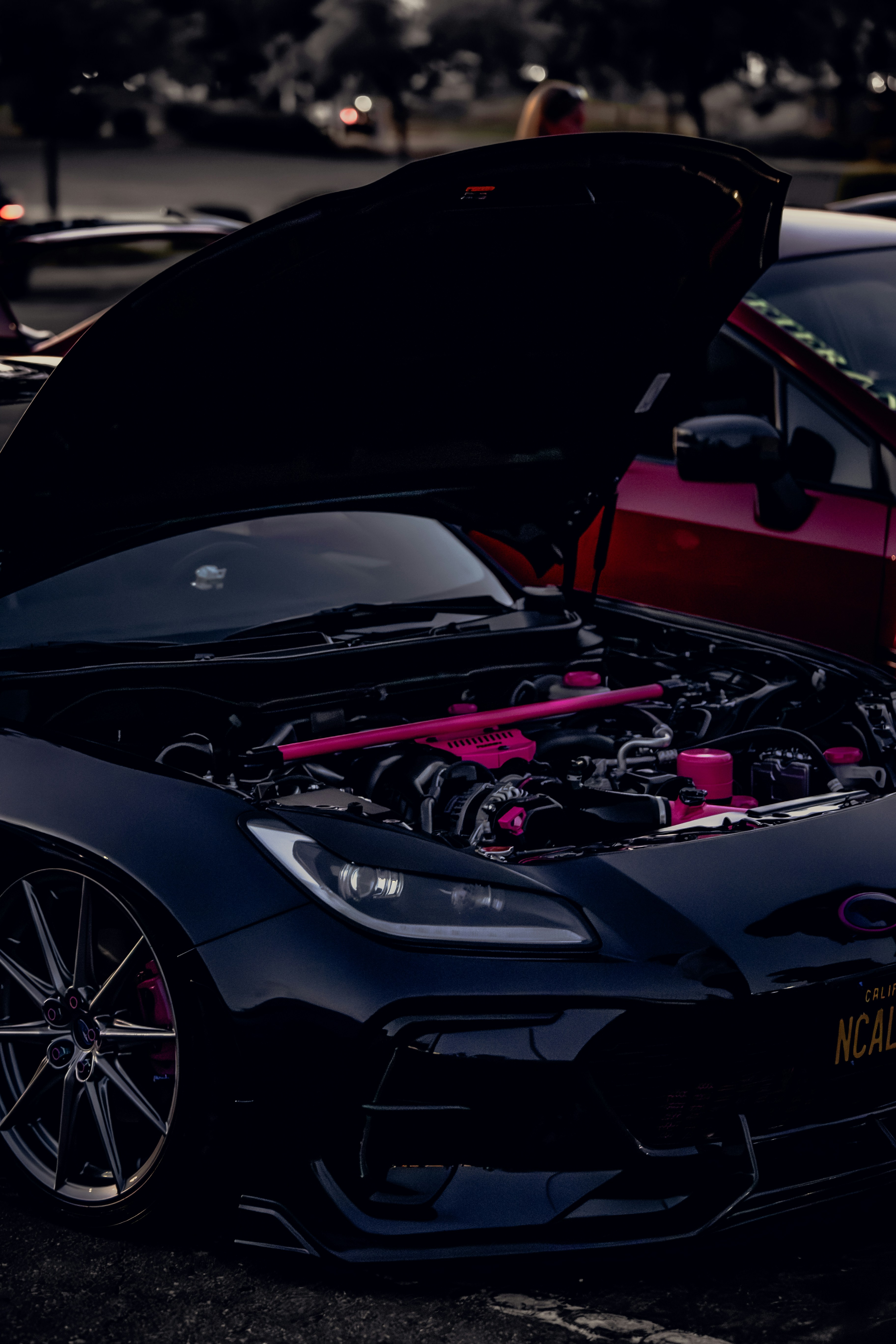 Sleek midnight engine reveal under a raised hood