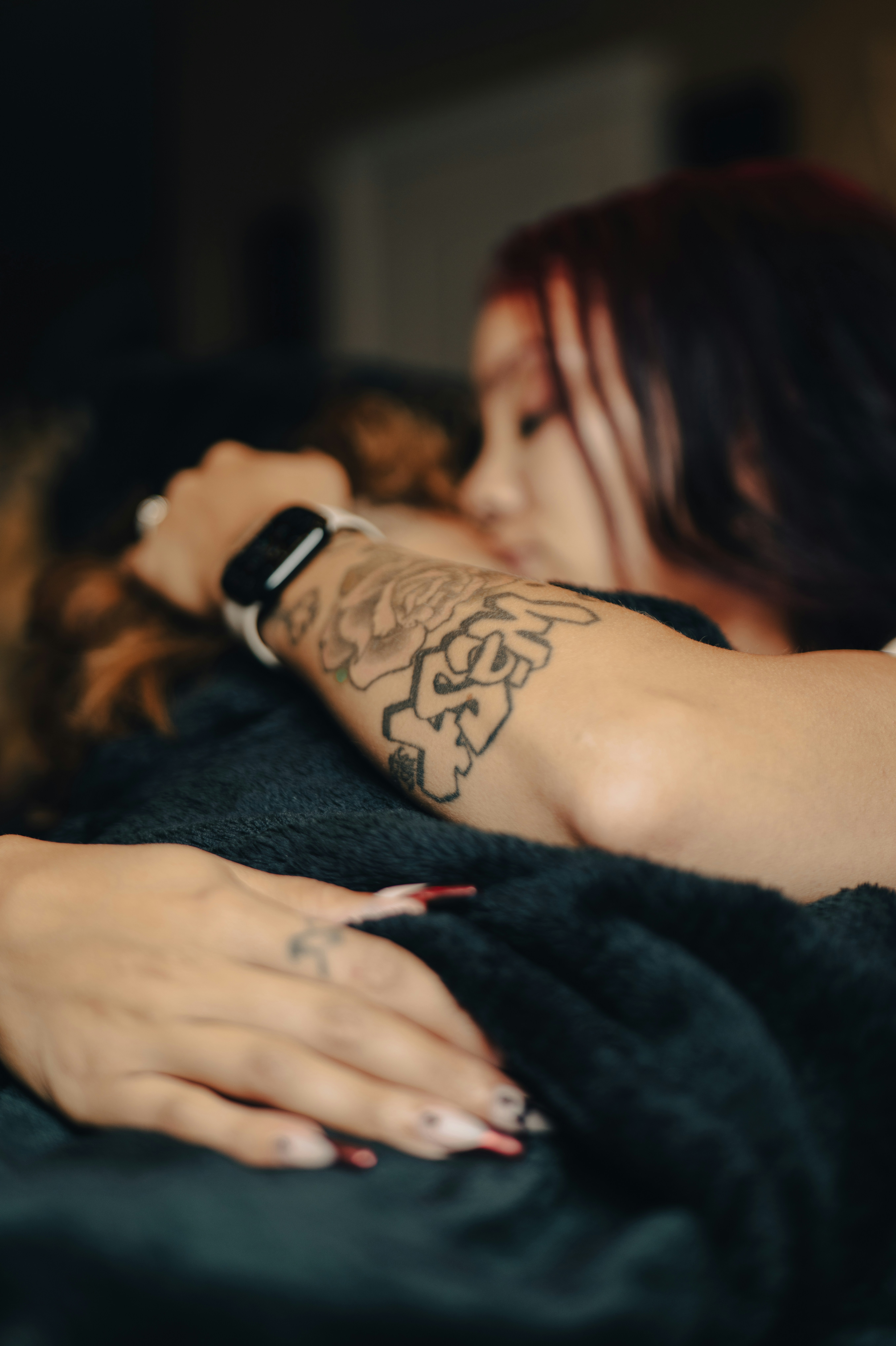 Close embrace: tattoos, glassy skin and a shared moment