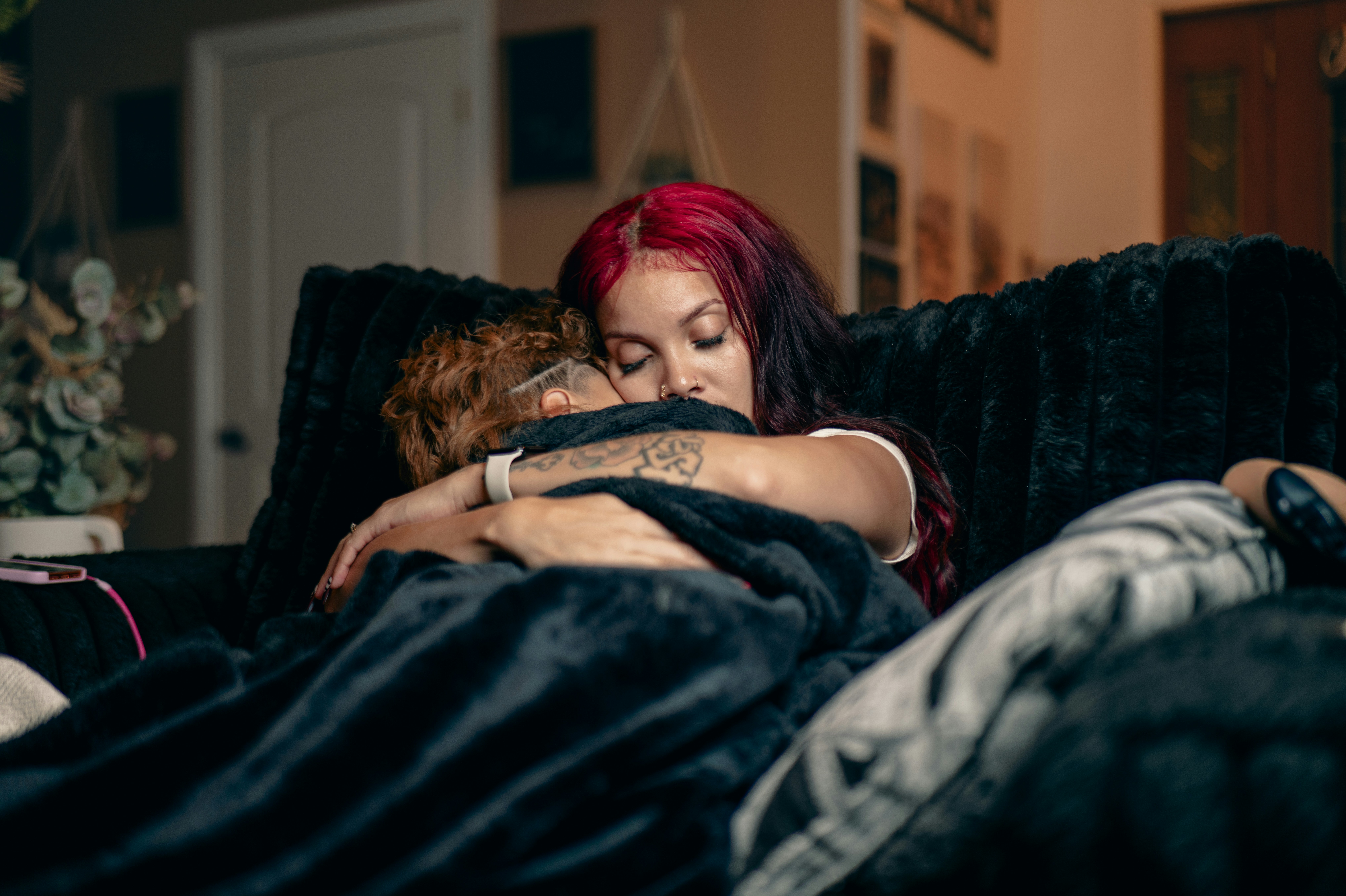 Red-Haired Embrace: Intimate Moment on a Plush Couch