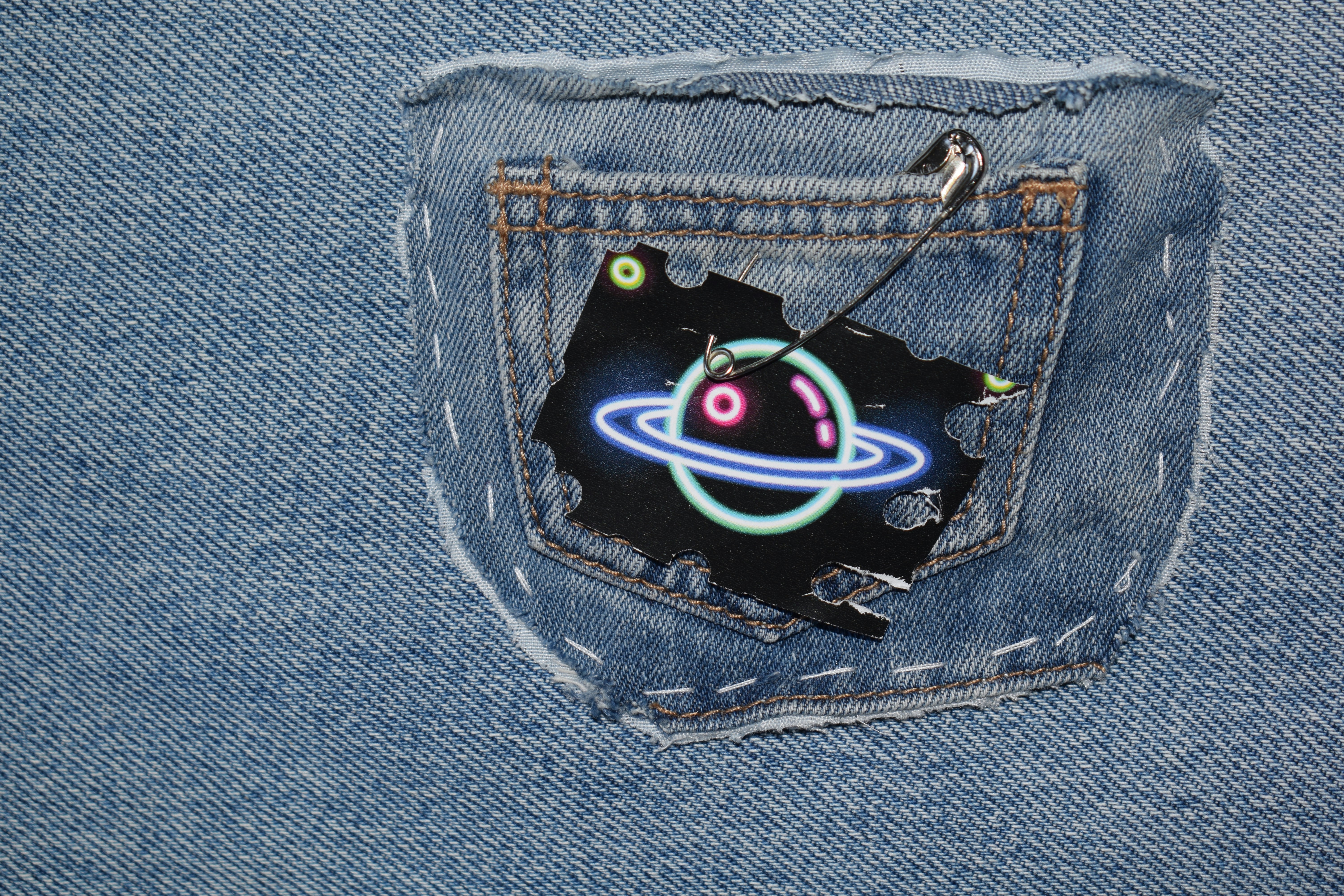 Neon Planet Burst on Denim: A Pocket-Space Clip