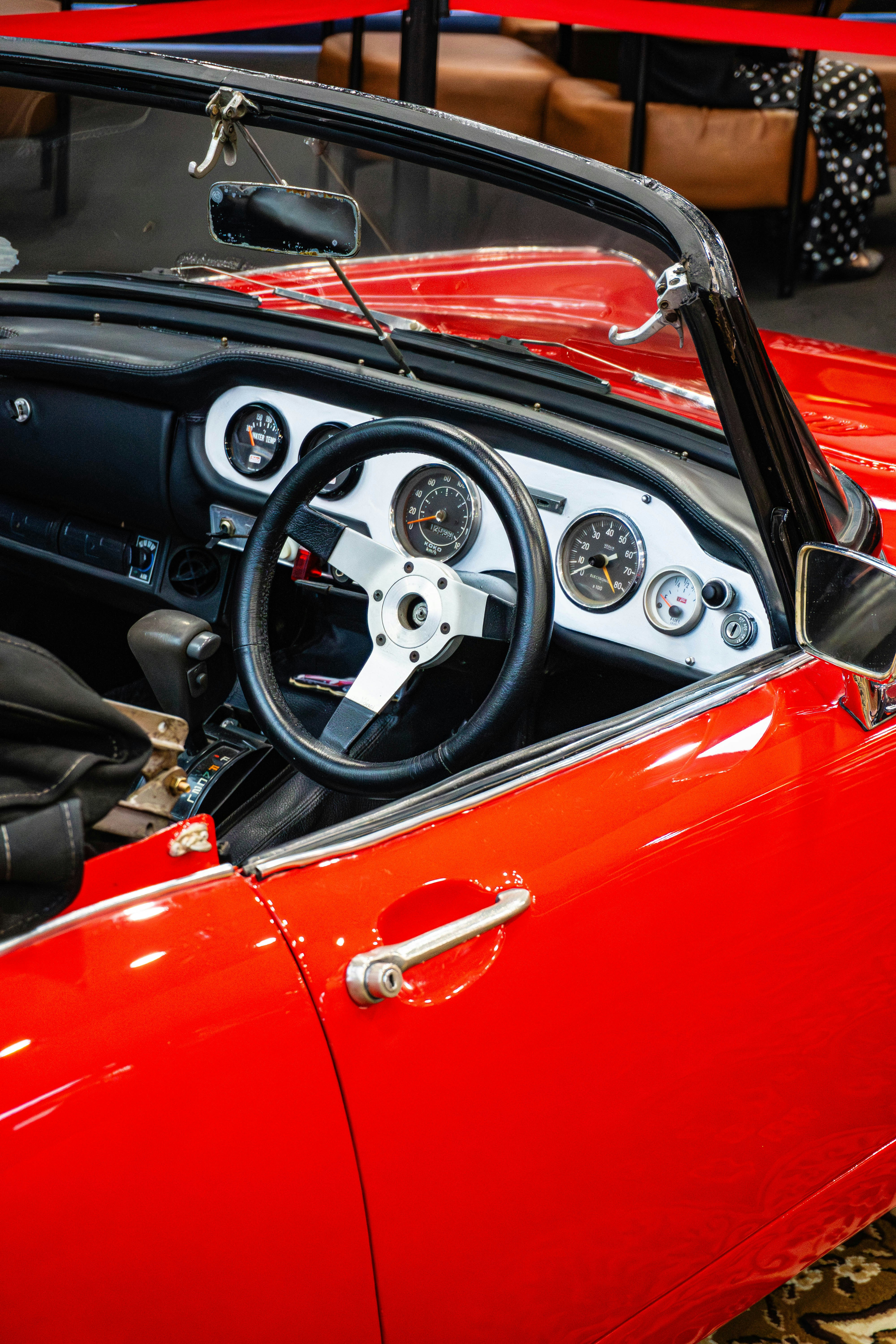 Red Convertible Cockpit: Classic Gauges and Spoked Wheel