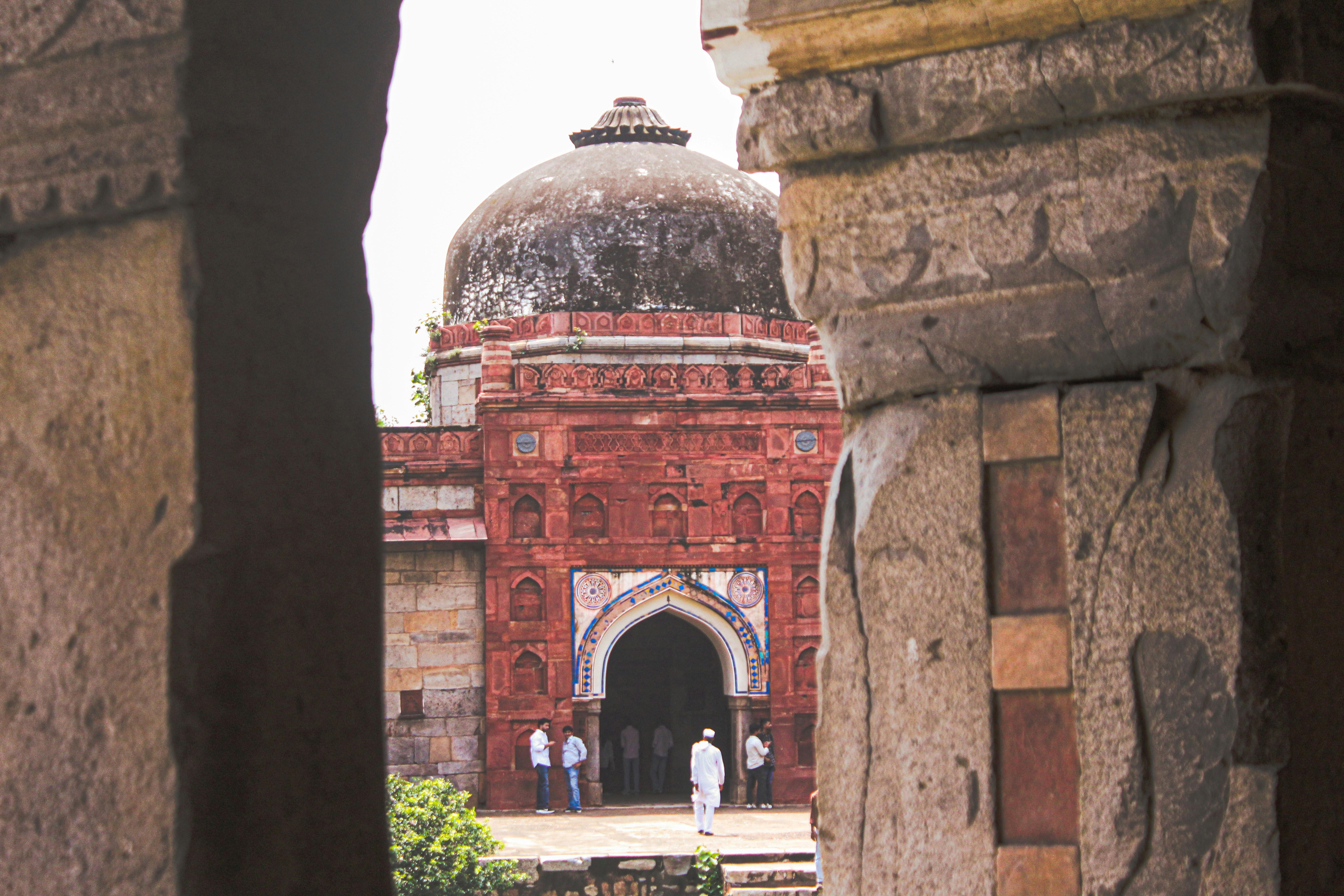 Gateways of History: Framing the Red Arch Through Ancient Stones