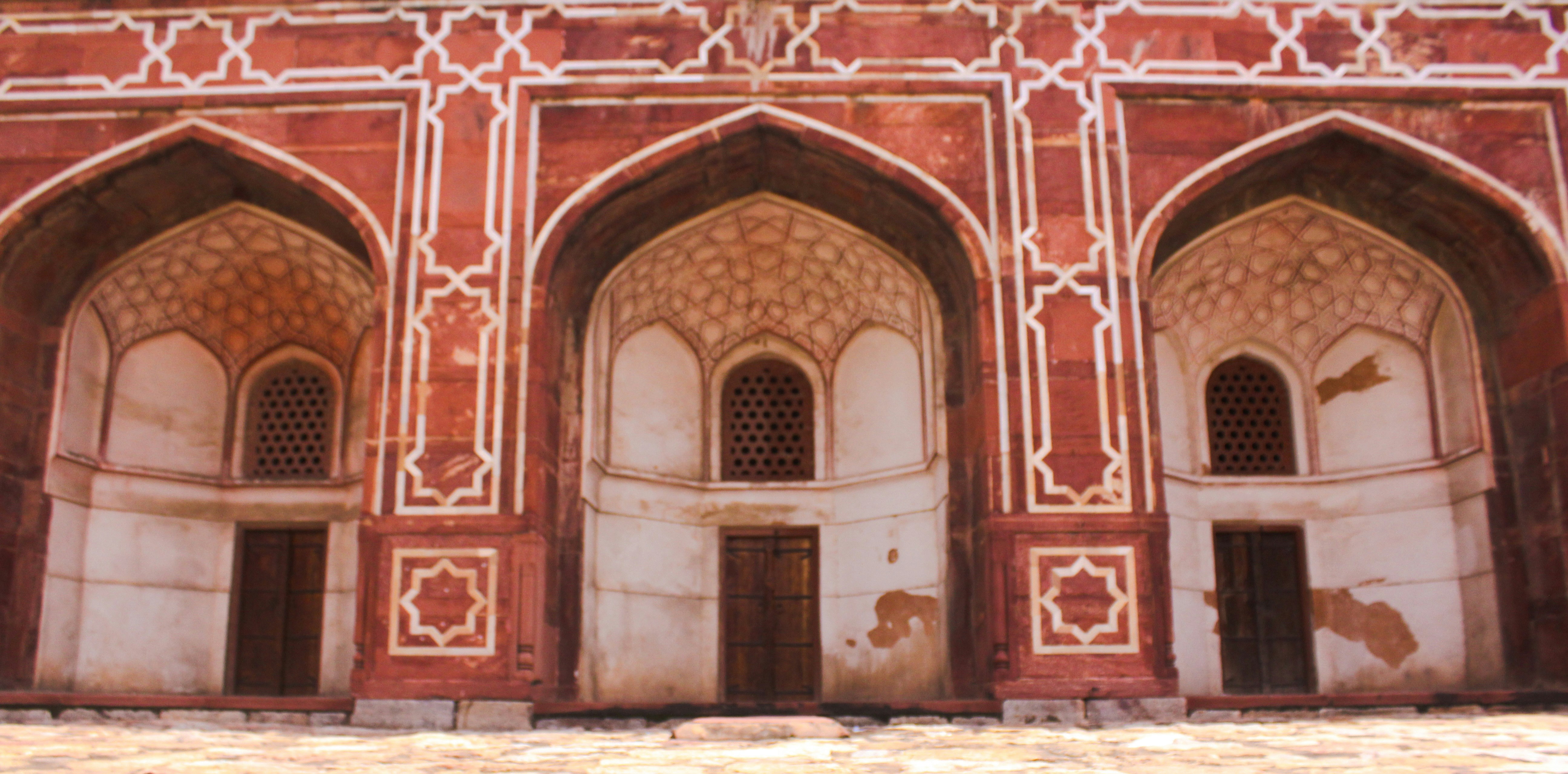 Three Archways in Red Brick Wall: Symmetry and Weathered Details