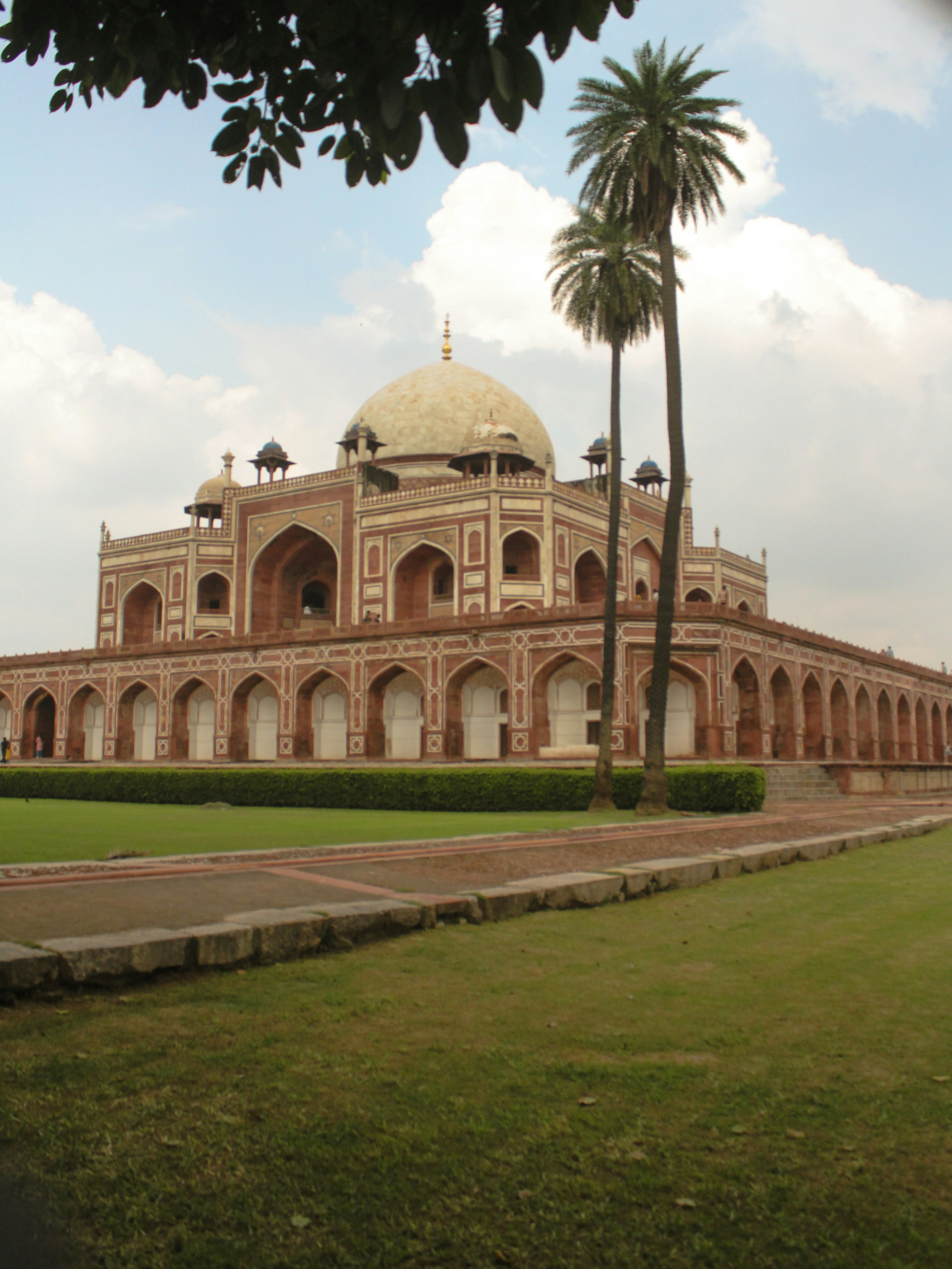 Red Sandstone Mosque Framed by Palm and Sky