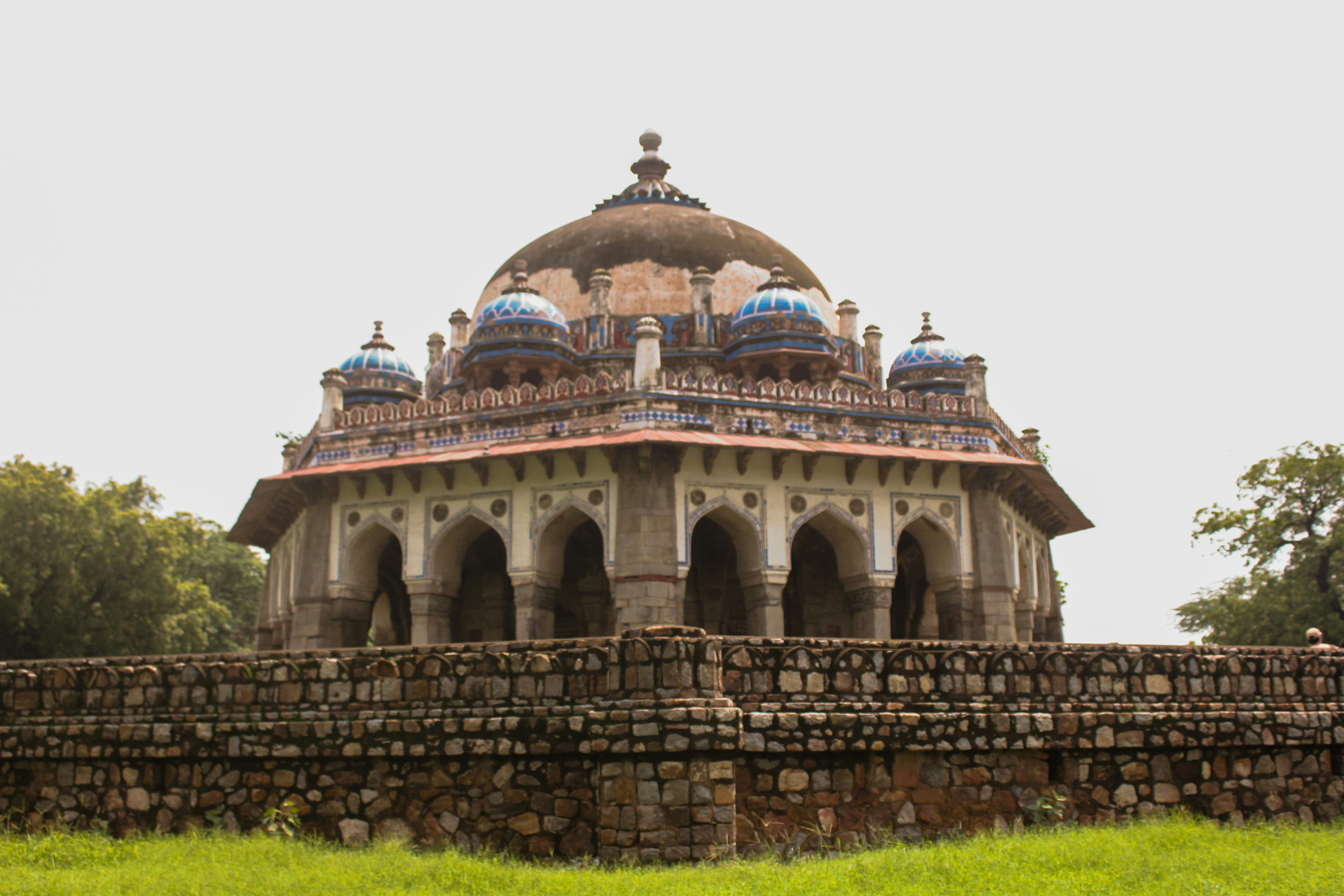 Blossoming Dome: A Stone Pavilion Rising Above Ancient Walls