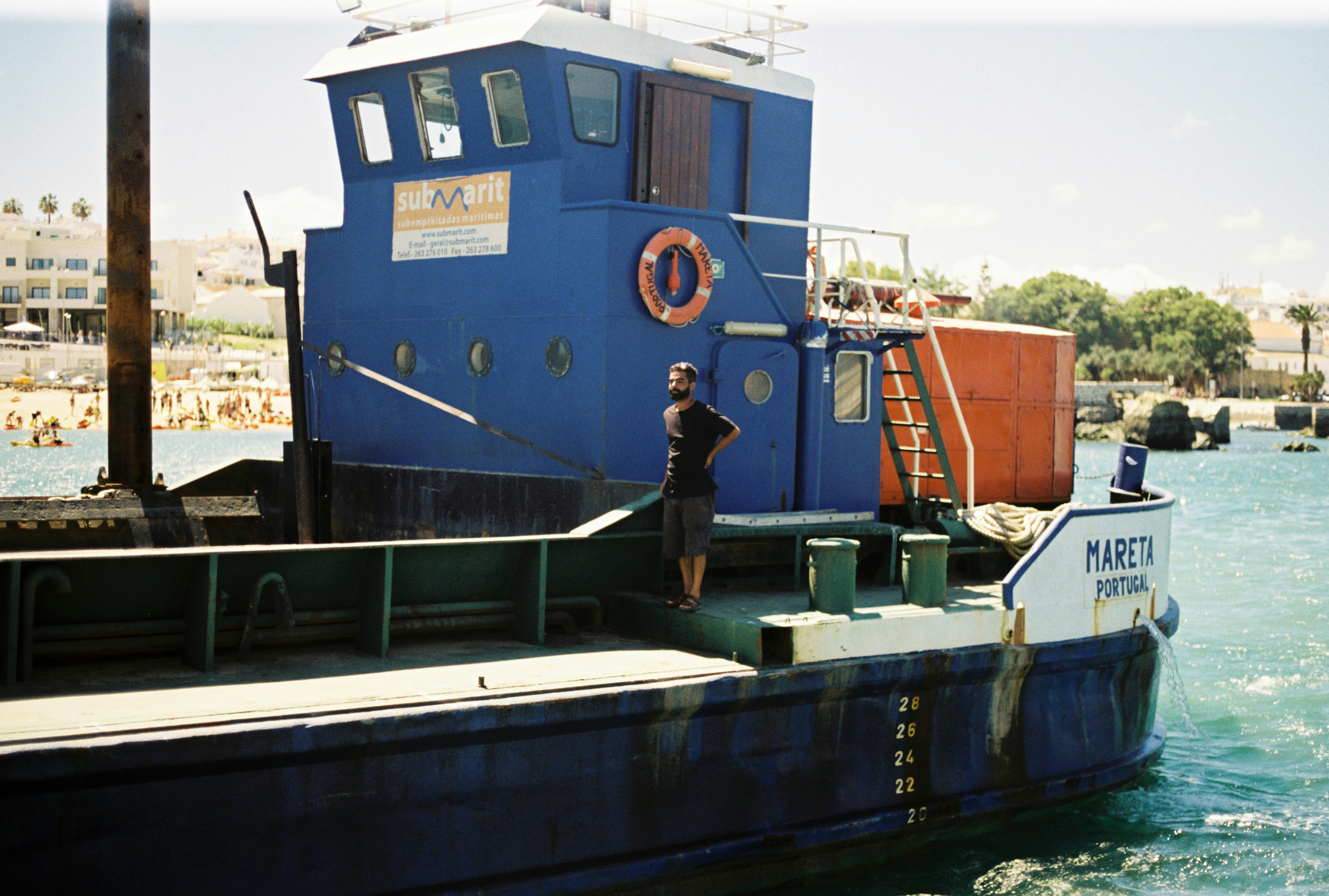 Blue Tug on the Sunlit Waterfront