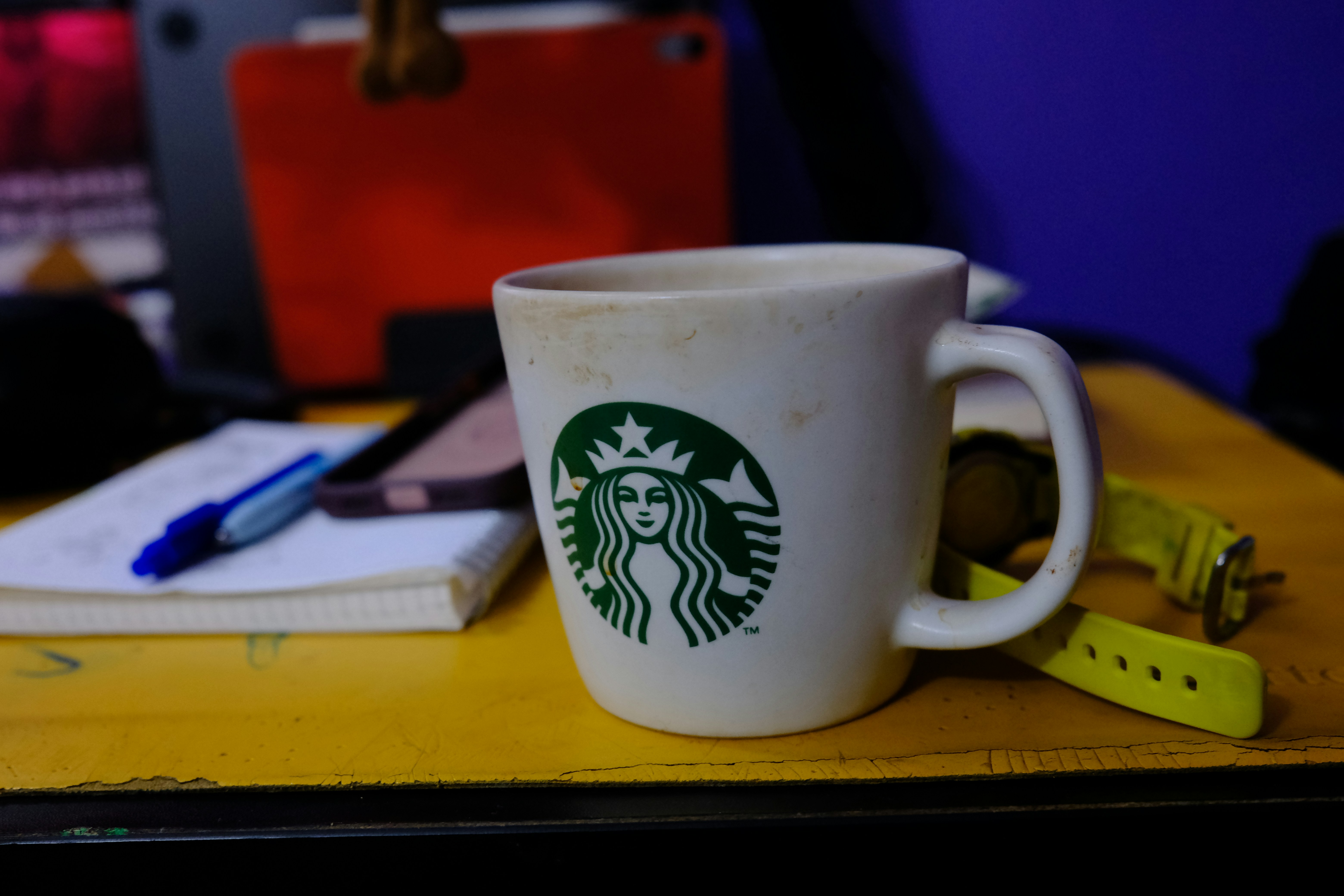 A Quiet Morning Brew: Starbucks Mug Centerstage on a Colorful Desk