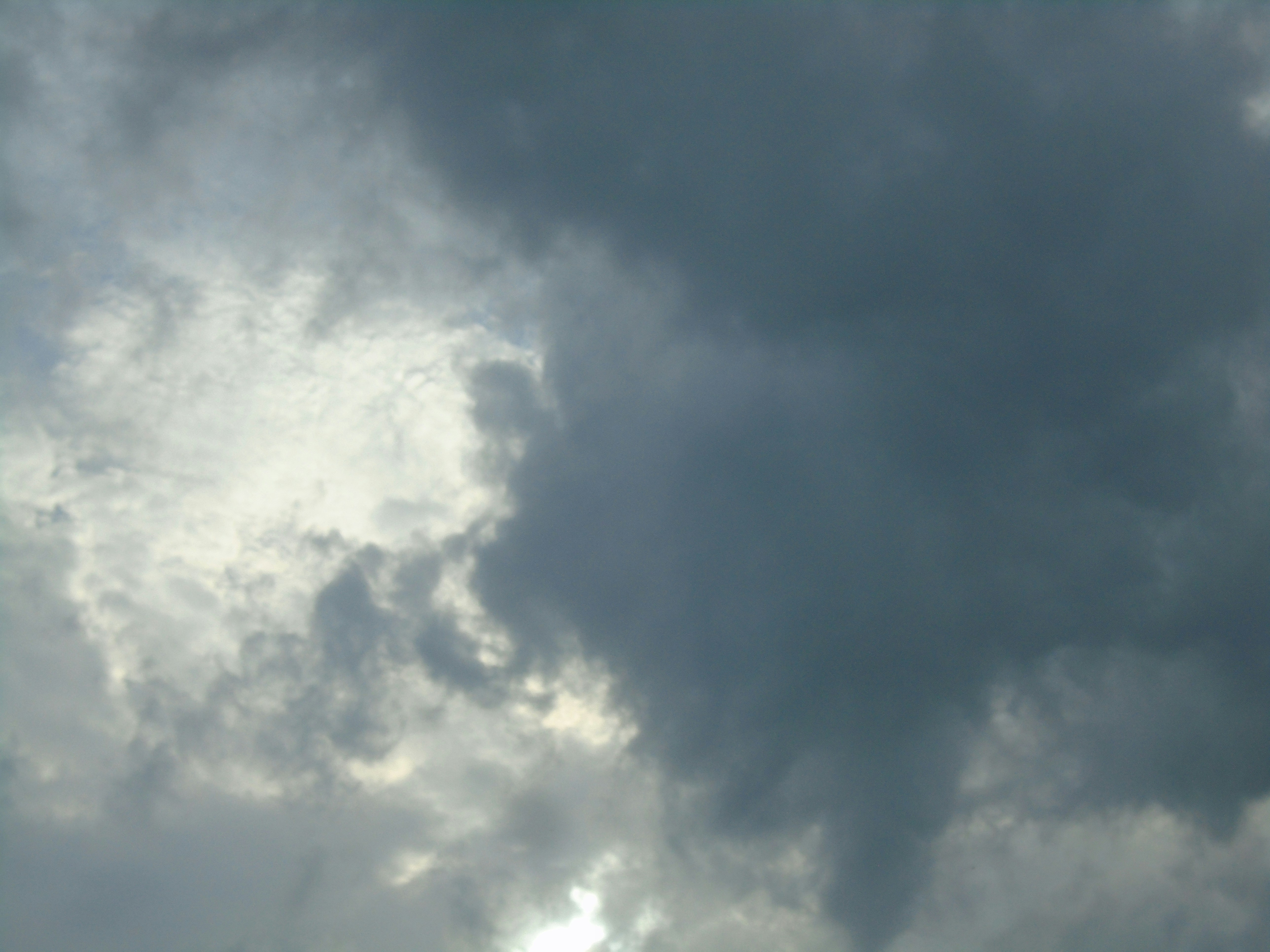 Cloud Break: Light Splits Through a Turmoil of Grey