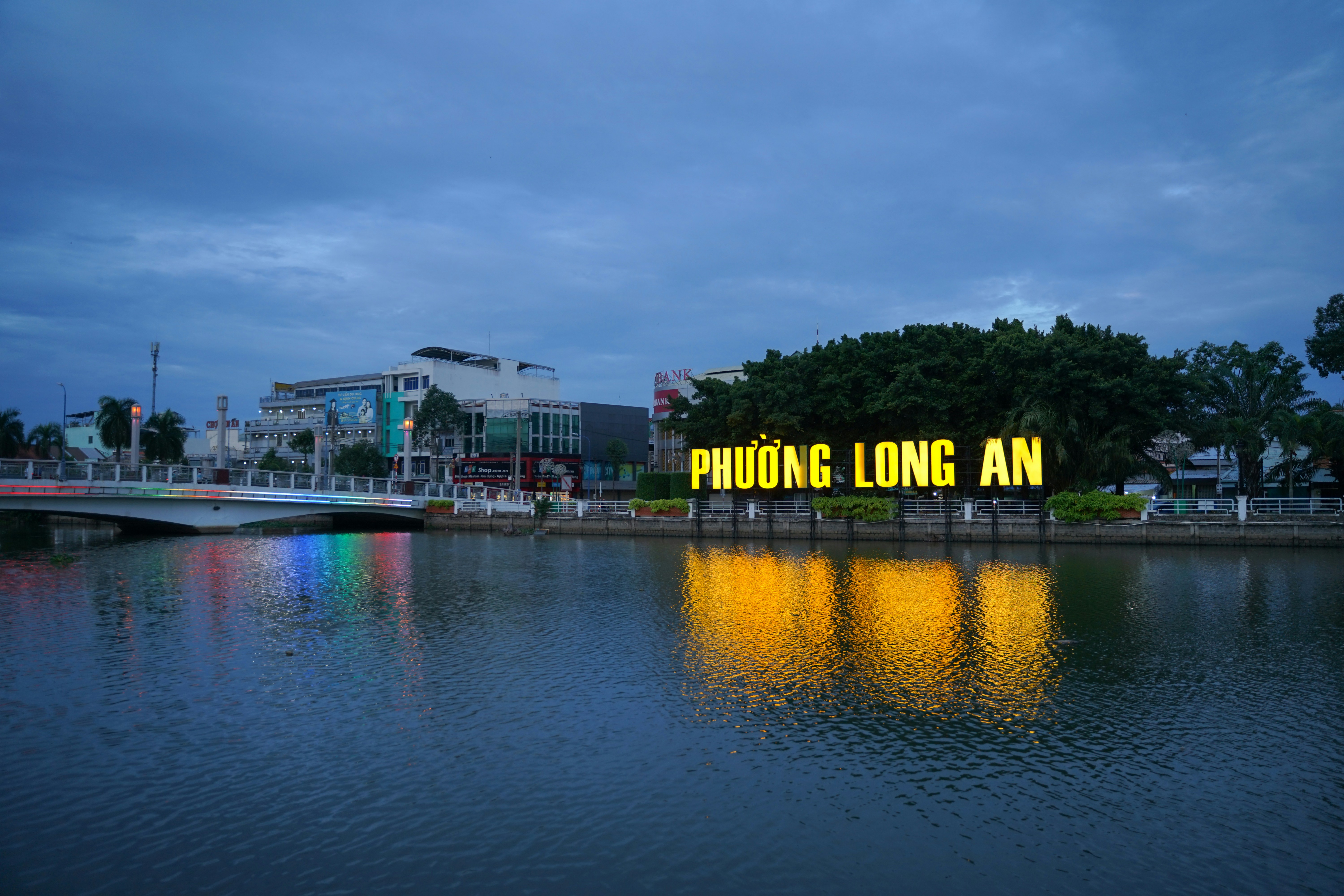 Luminous Sign by the River: Phuong Long An in Neon Glow