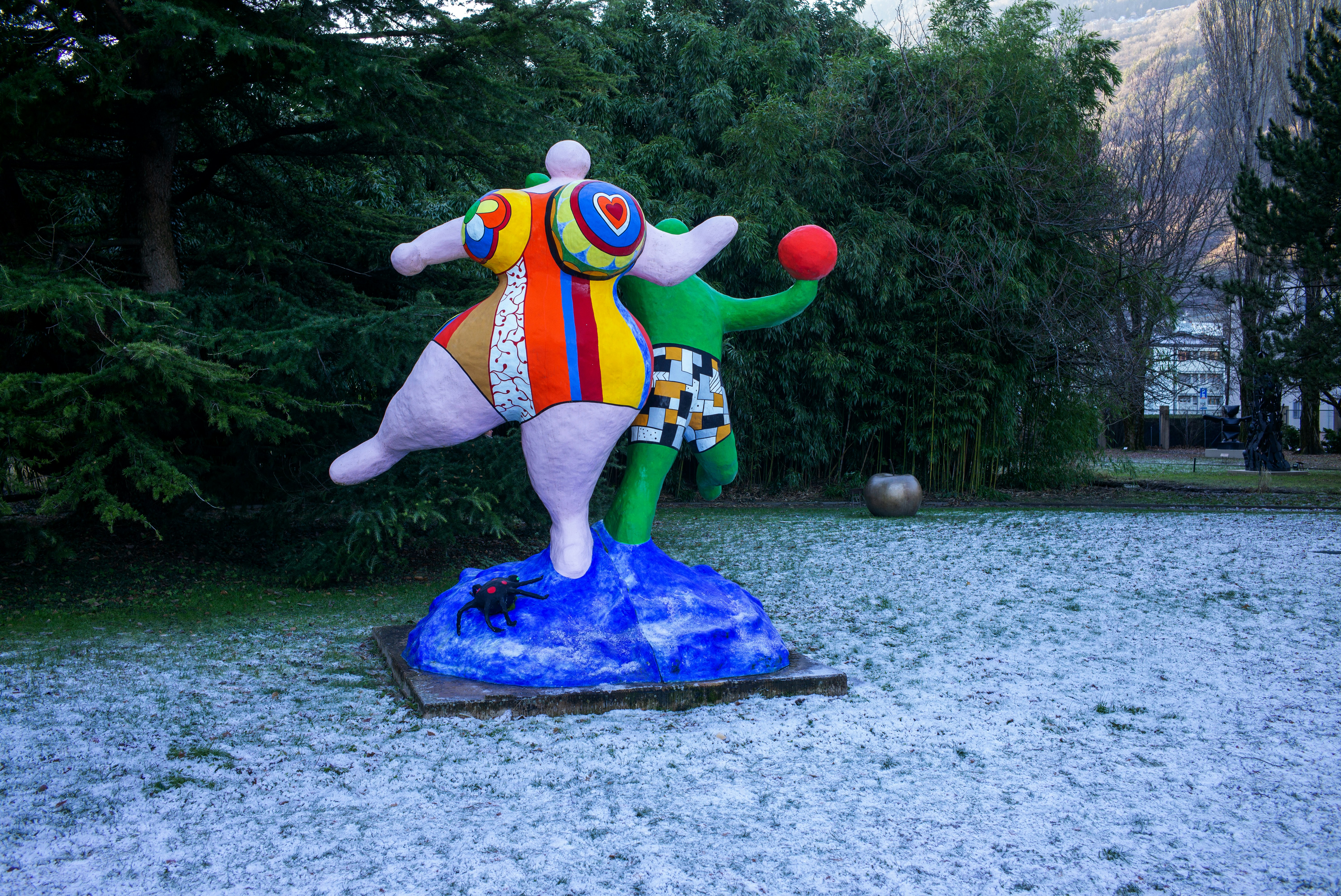 Kaleidoscope of Motion: Colorful Sculpture on a Snowy Pond